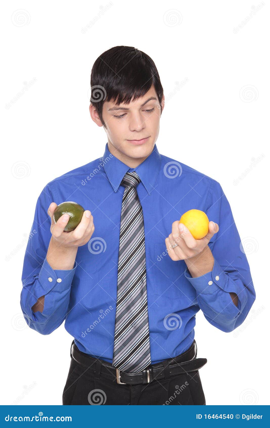 Caucasian Man Comparing Lime To Lemon Stock Photo - Image of sweater ...