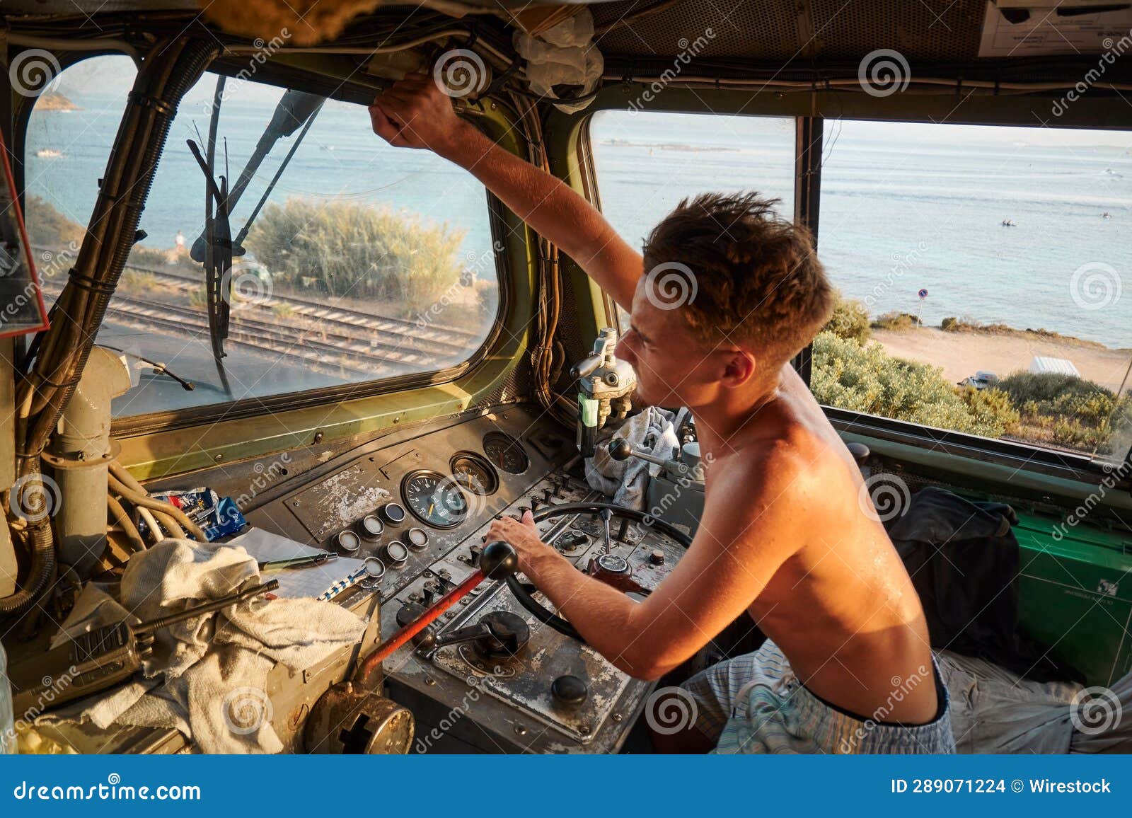 Caucasian Man in the Driver& X27;s Cab of a Large Locomotive, Adjusting ...