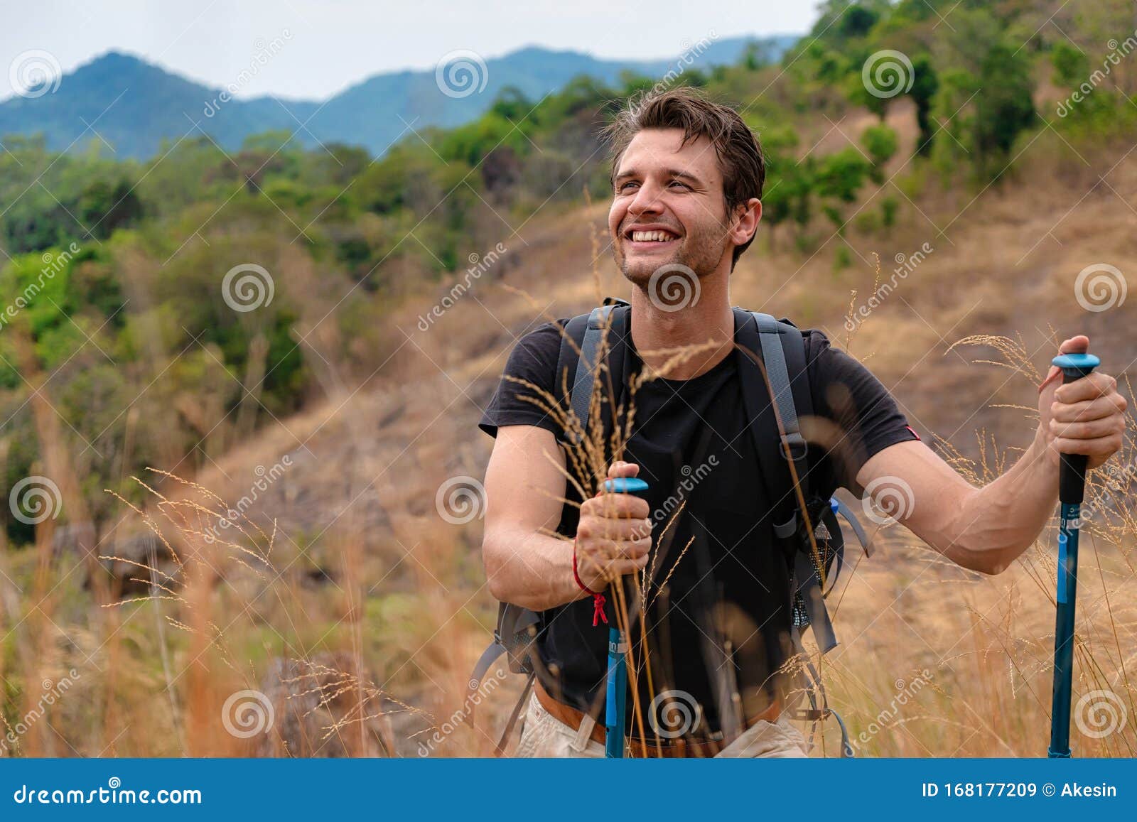 Caucasian Man Hiker Having Fun Walking Up Mountain on Trail with Dry ... Caucasian Man Hiker Having Fun Walking Up Mountain on Trail with Dry ...