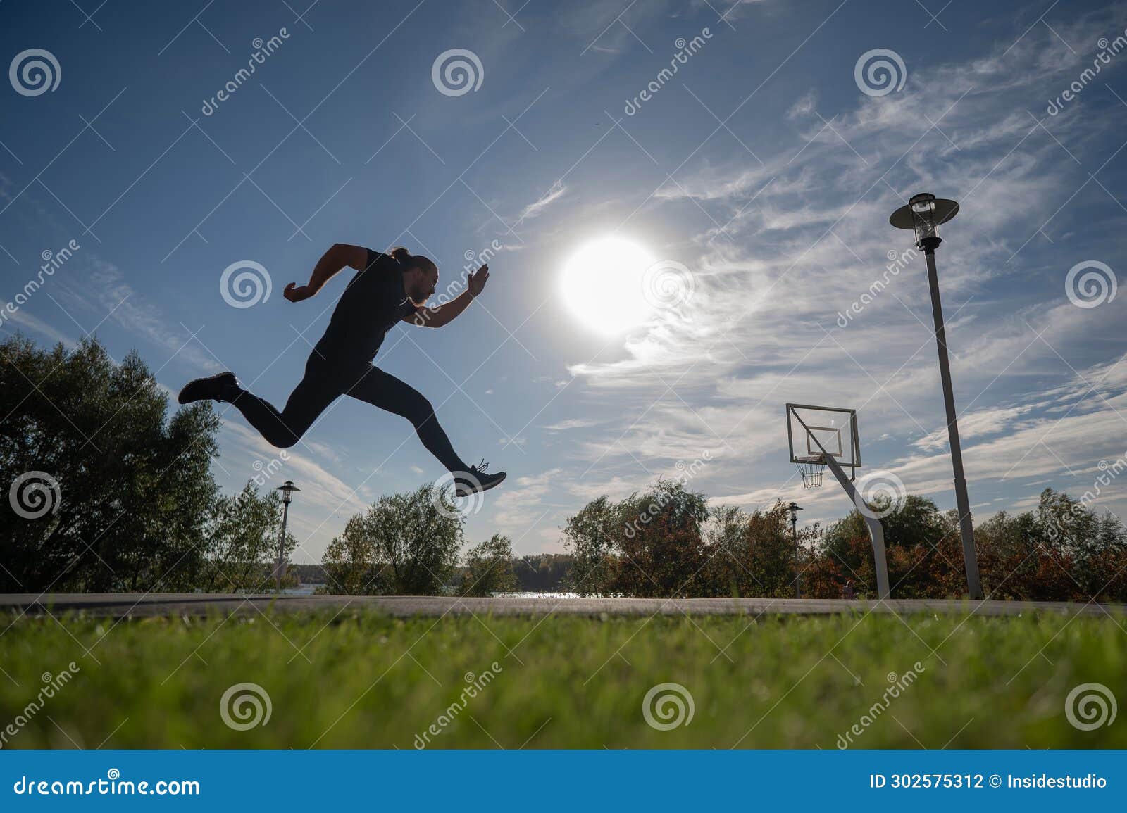 Caucasian Man Jumping with High Hip Raise Outdoors. Stock Photo - Image ...