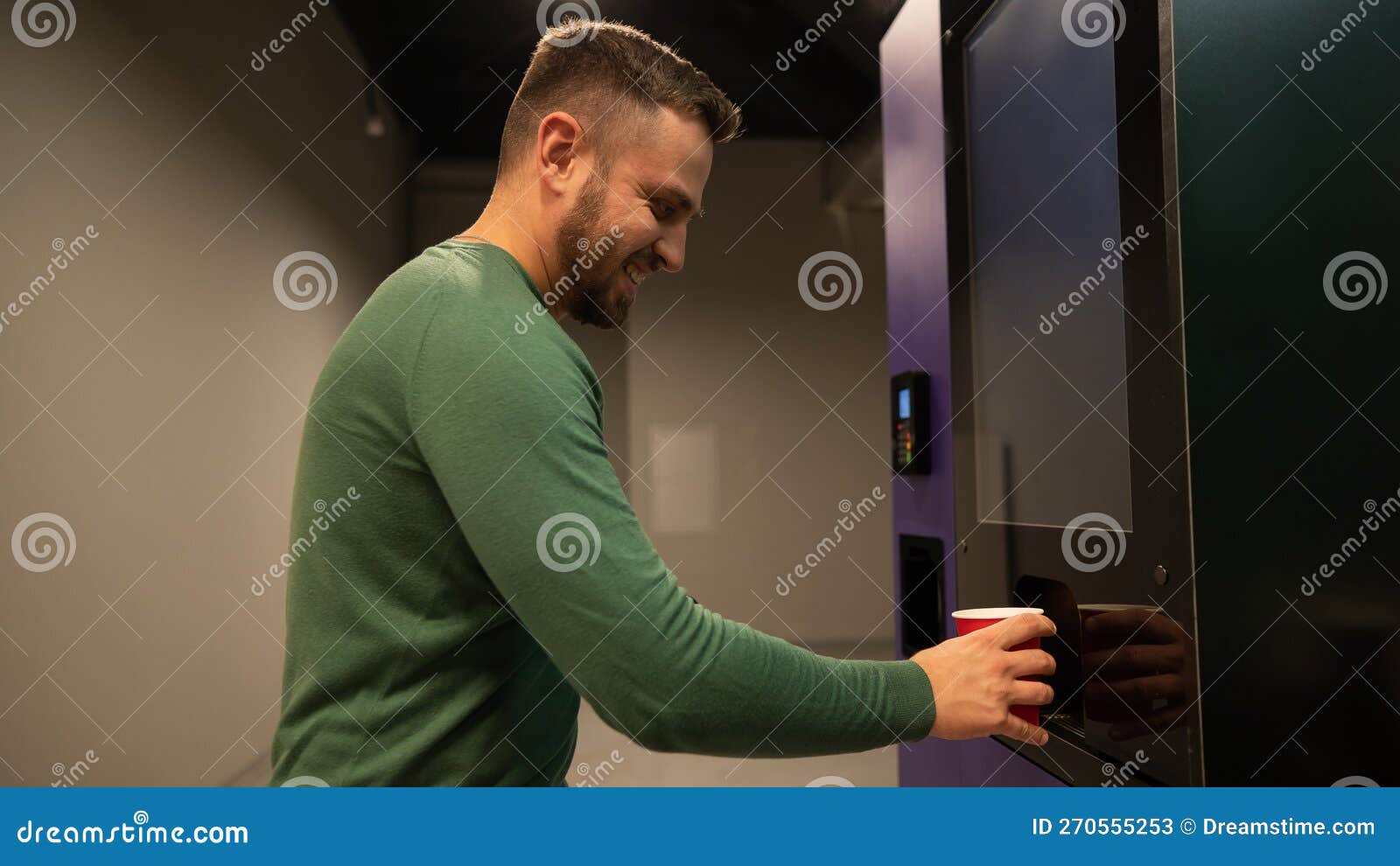 Caucasian Man Pours Himself Coffee from a Vending Machine. Stock Image ...