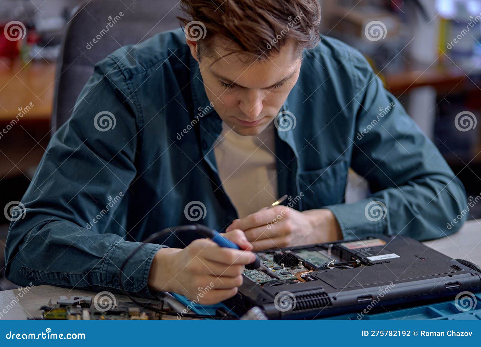 Confident Serious Male Repairing Parts in Disassembled Laptop Using ...