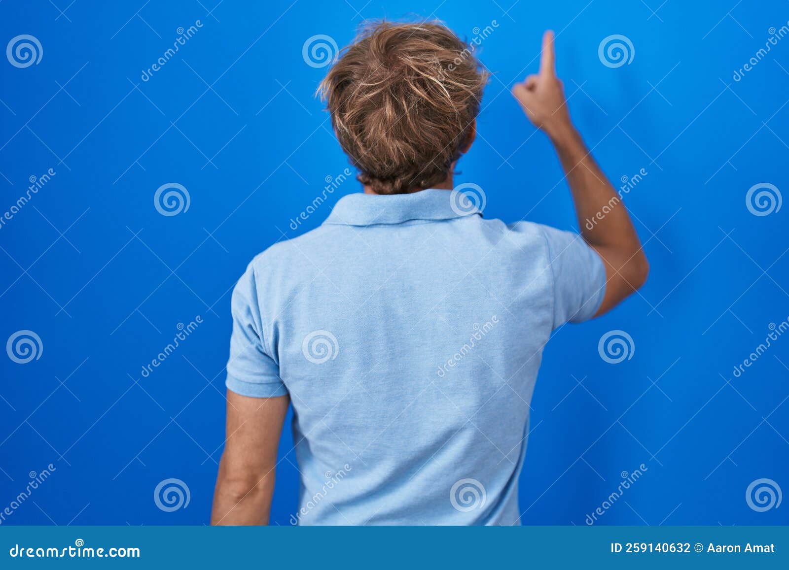 Caucasian Man Standing Over Blue Background Posing Backwards Pointing ...