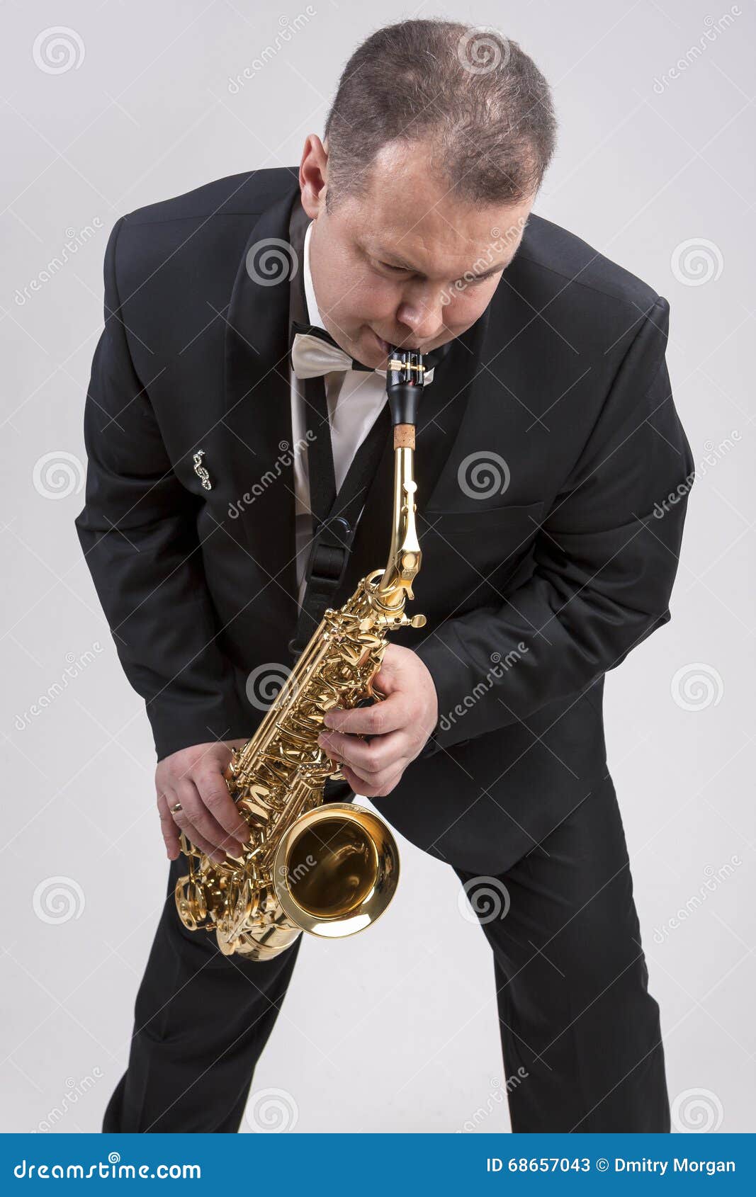 Caucasian Man in Suite Playing the Saxophone. Posing Against White ...