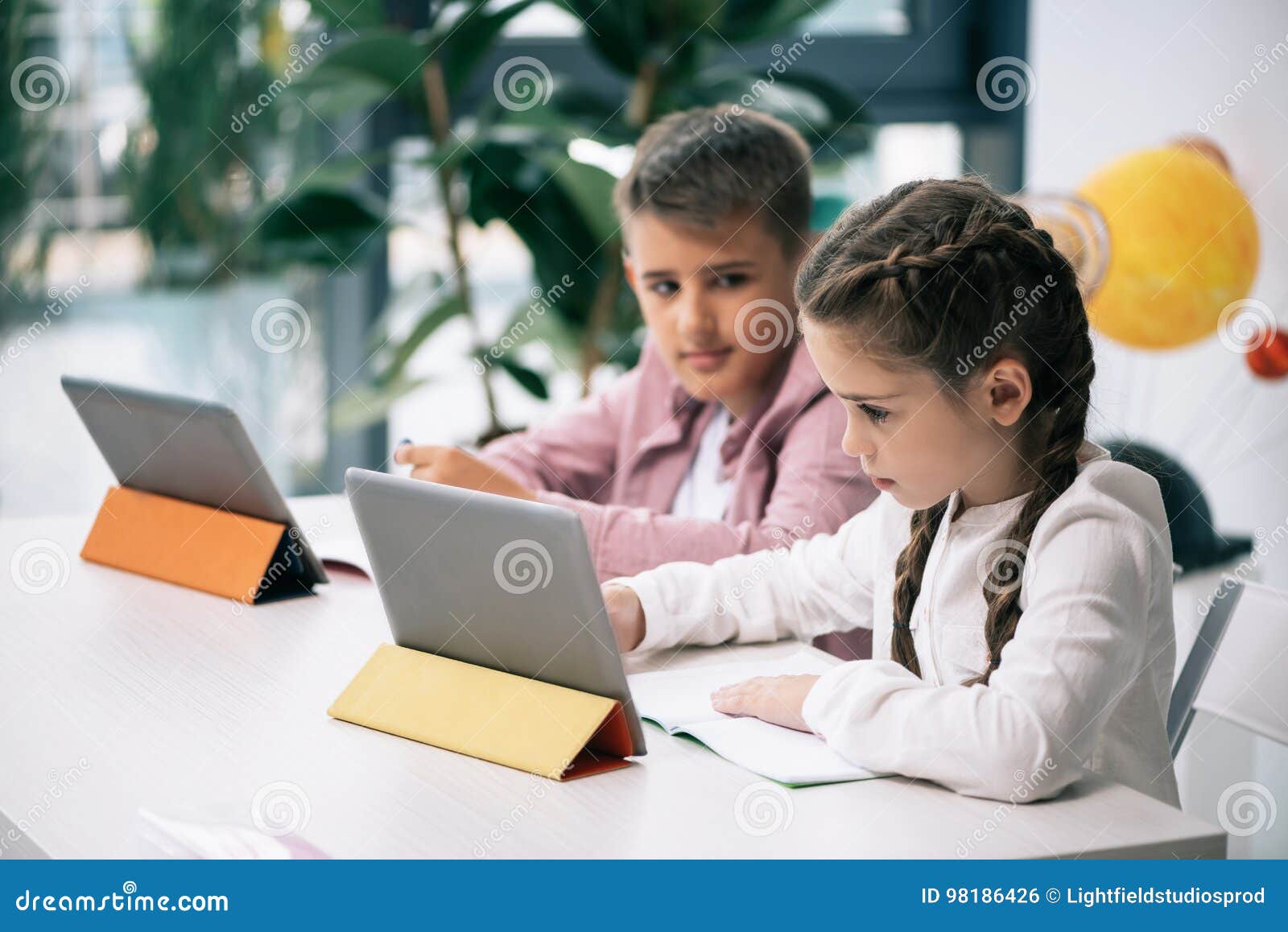 Caucasian Schoolkids Using Digital Tablets while Studying Together in ...
