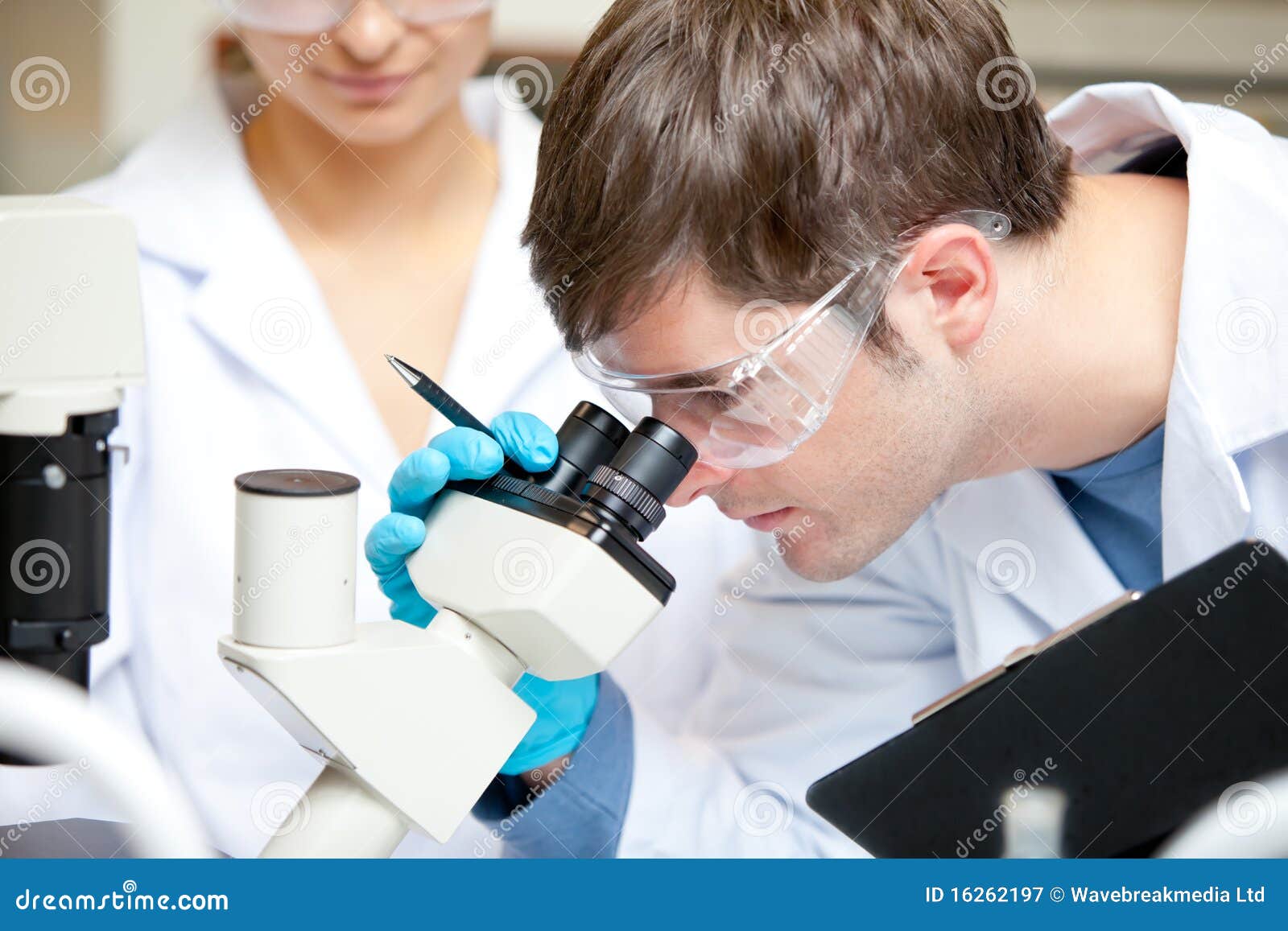 Caucasian Scientist Looking through a Microscope Stock Image - Image of ...