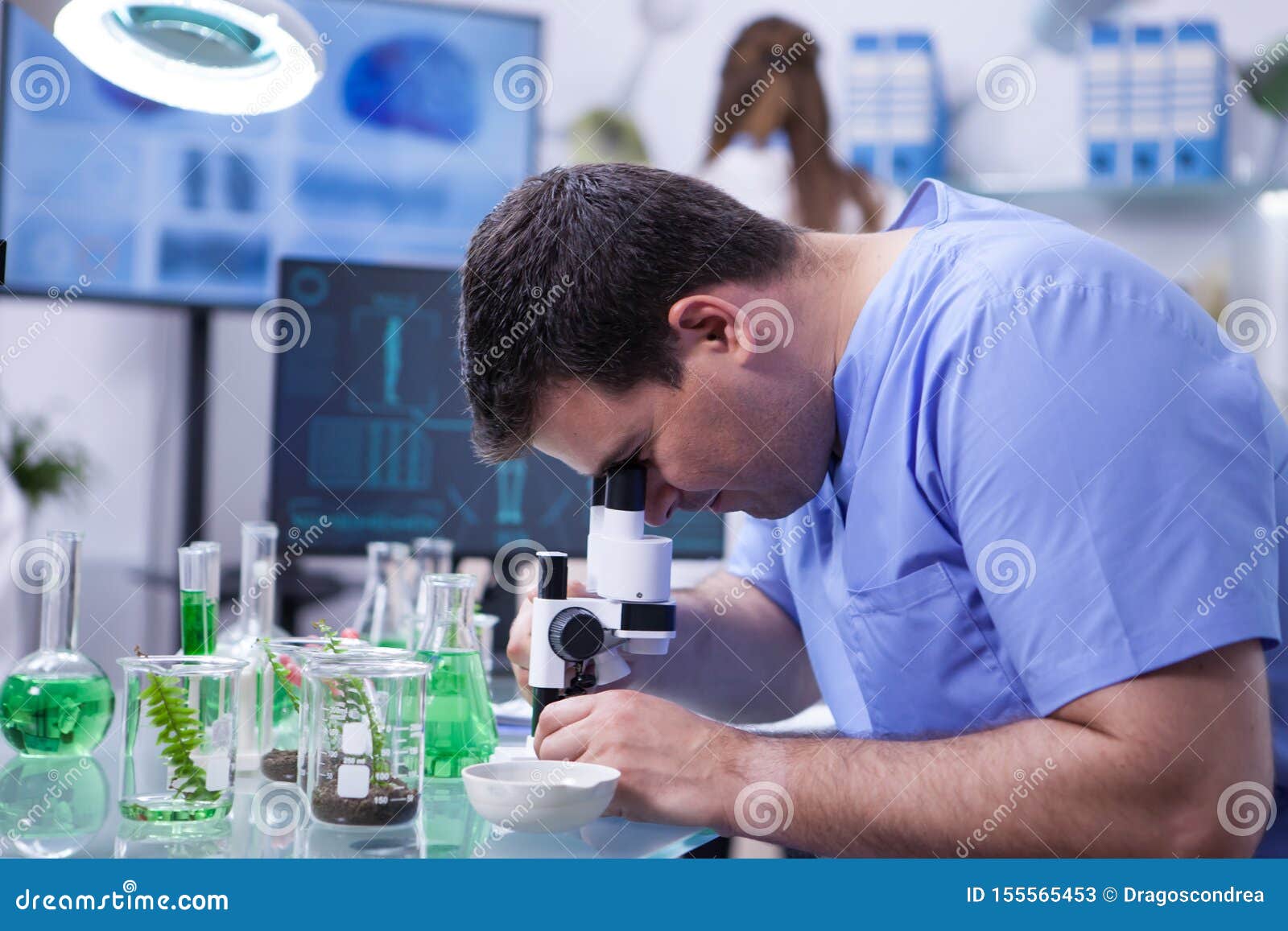 Caucasian Scientist Man in a Biotechnology Lab Looking through ...