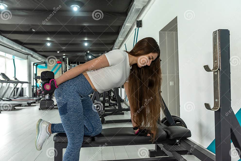 Caucasian Athletic Fitness Instructor Doing Exercises in Her Arms ... Caucasian Athletic Fitness Instructor Doing Exercises in Her Arms ...