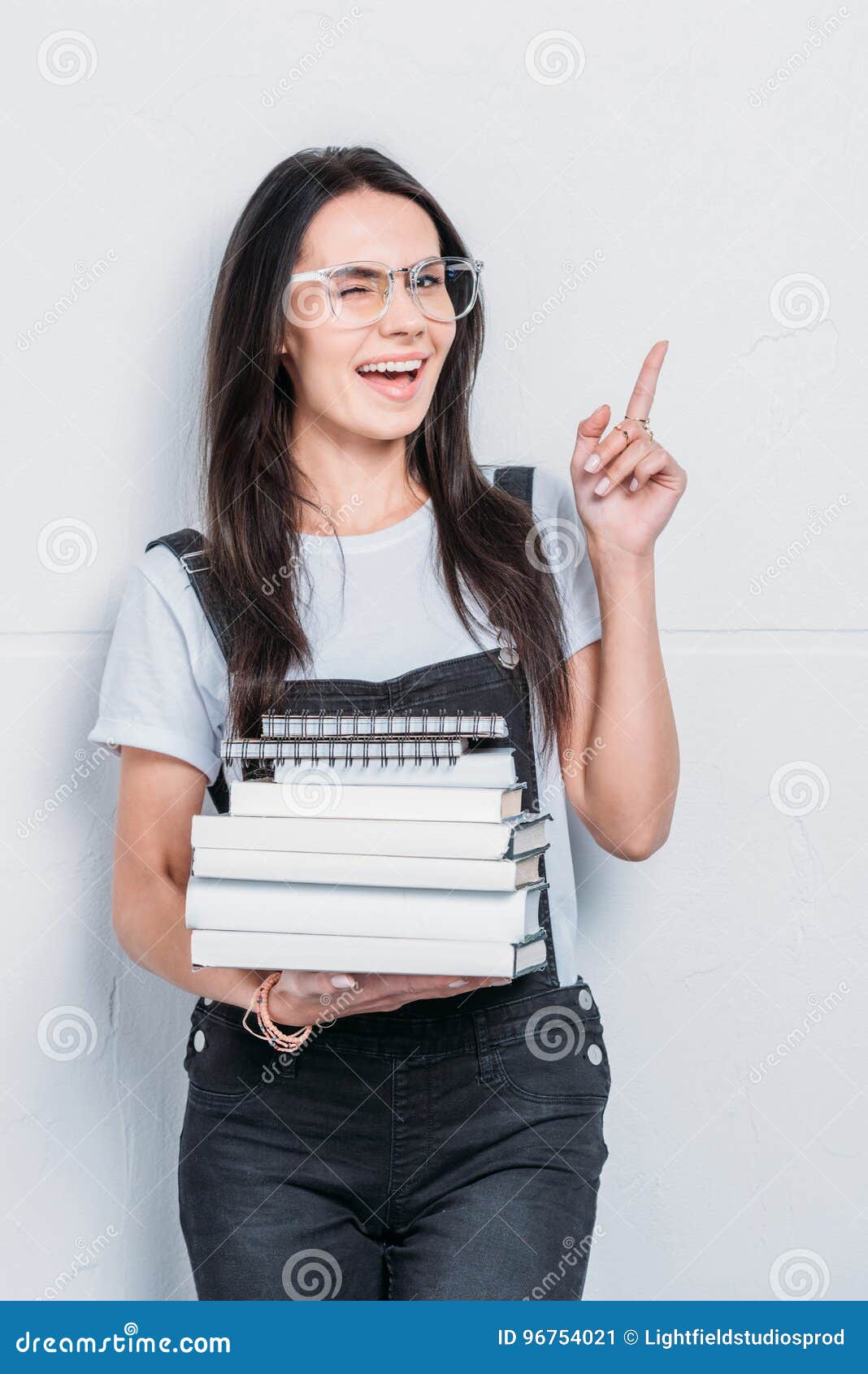 Caucasian Student Holding Books and Pointing with Finger Stock Image ...