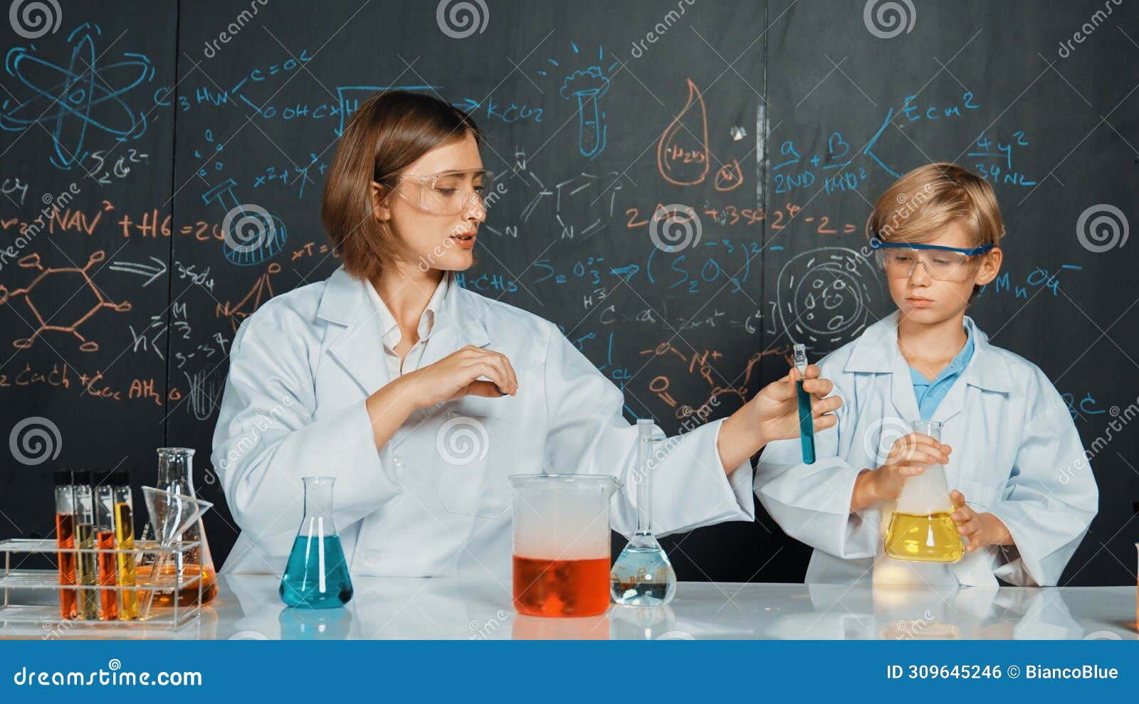 Caucasian Teacher Helps Student Mixed Liquid in Science Laboratory ...