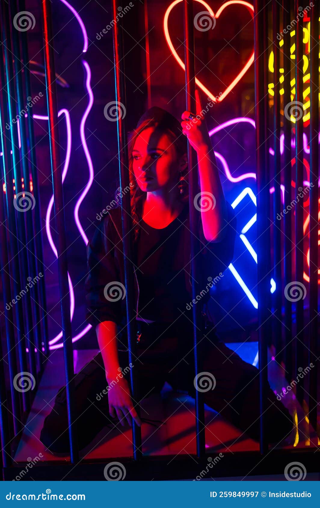 Caucasian Woman in a Cage in a Neon Studio. Stock Image - Image of ...