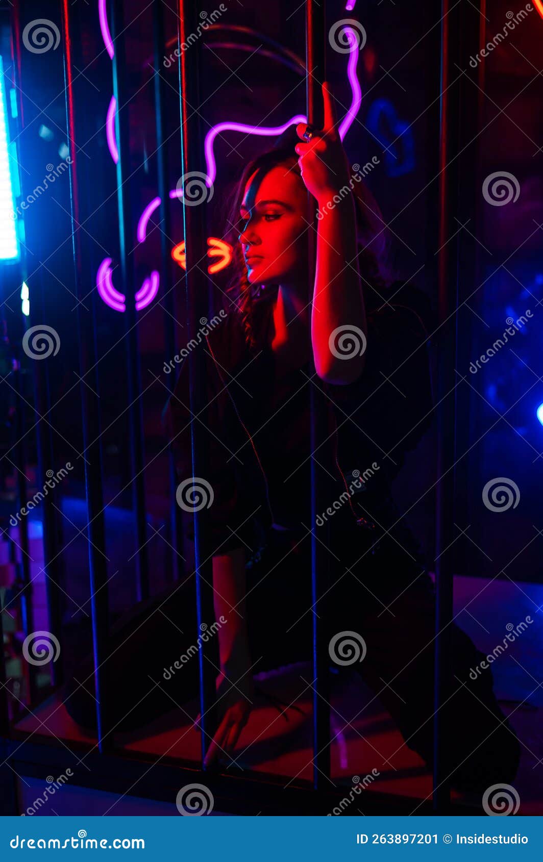 Caucasian Woman in a Cage in a Neon Studio. Stock Image - Image of lady ...
