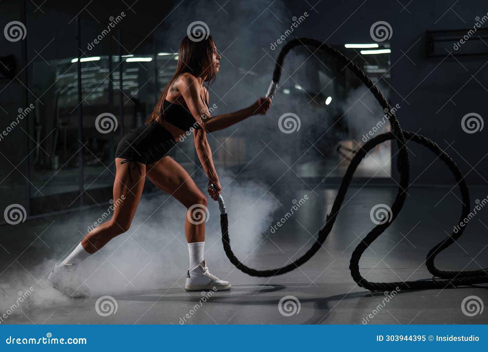 Caucasian Woman Doing Exercise with Ropes. Circuit Training in the Gym ...