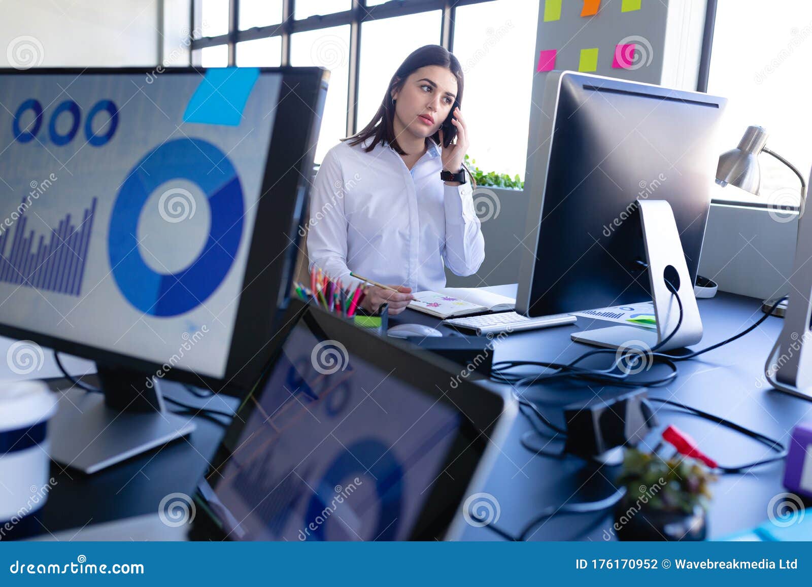 Caucasian Woman Working on Computer with Statistics on Screen Stock ...