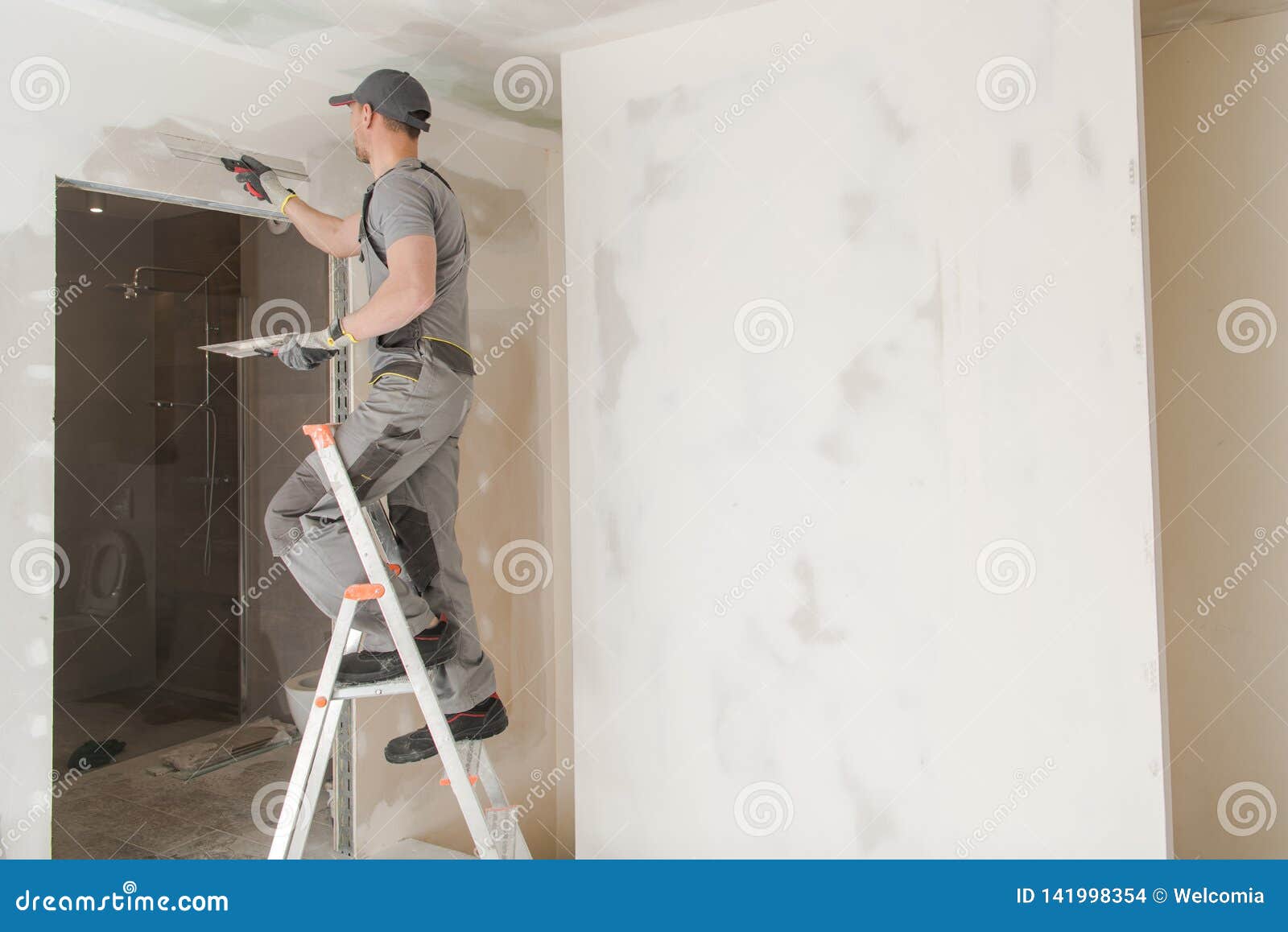 Worker Patching Drywall stock photo. Image of house - 141998354