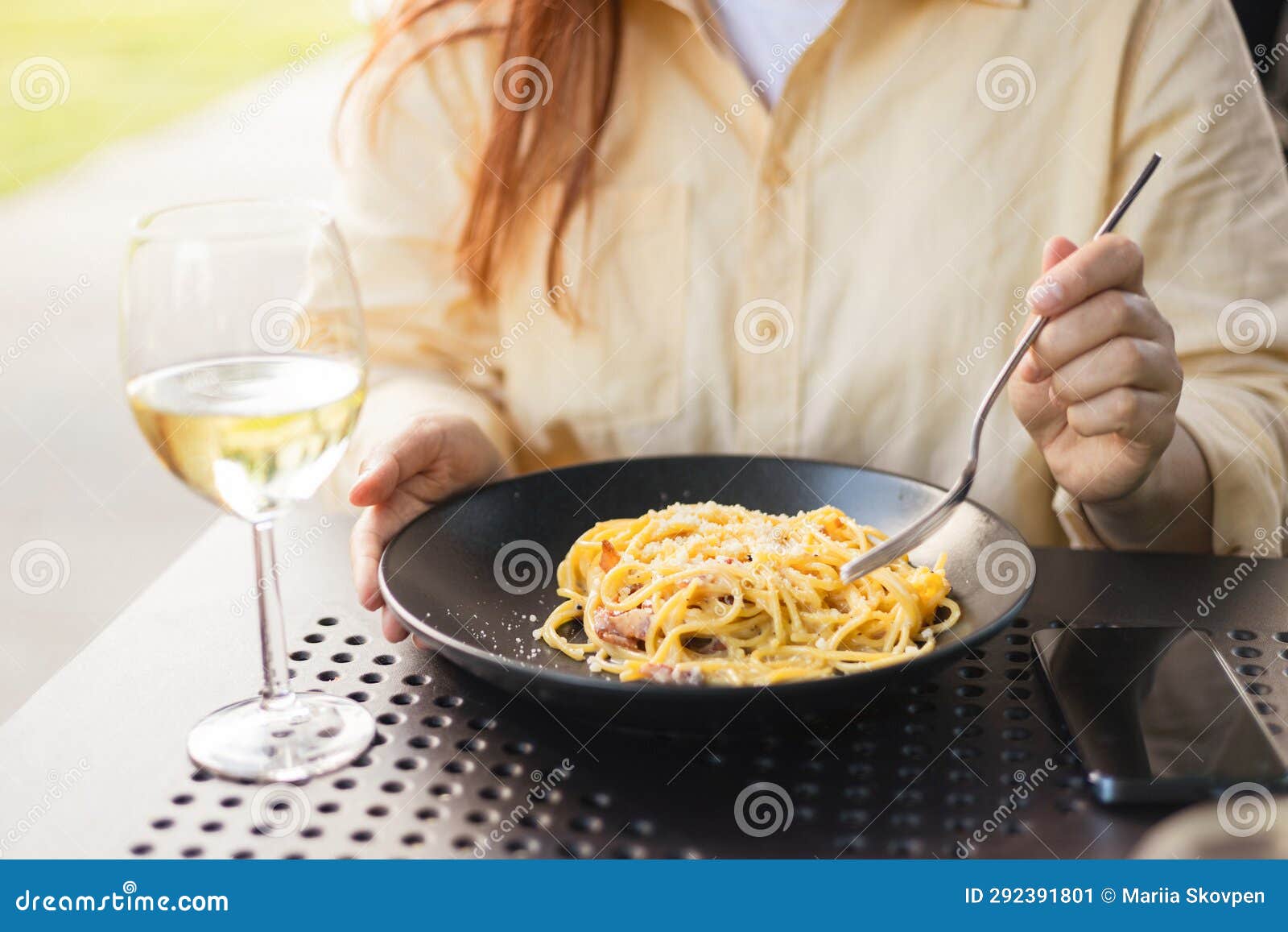 Caucasian Young Woman Eating Pasta Carbonara And Drinking White Wine
