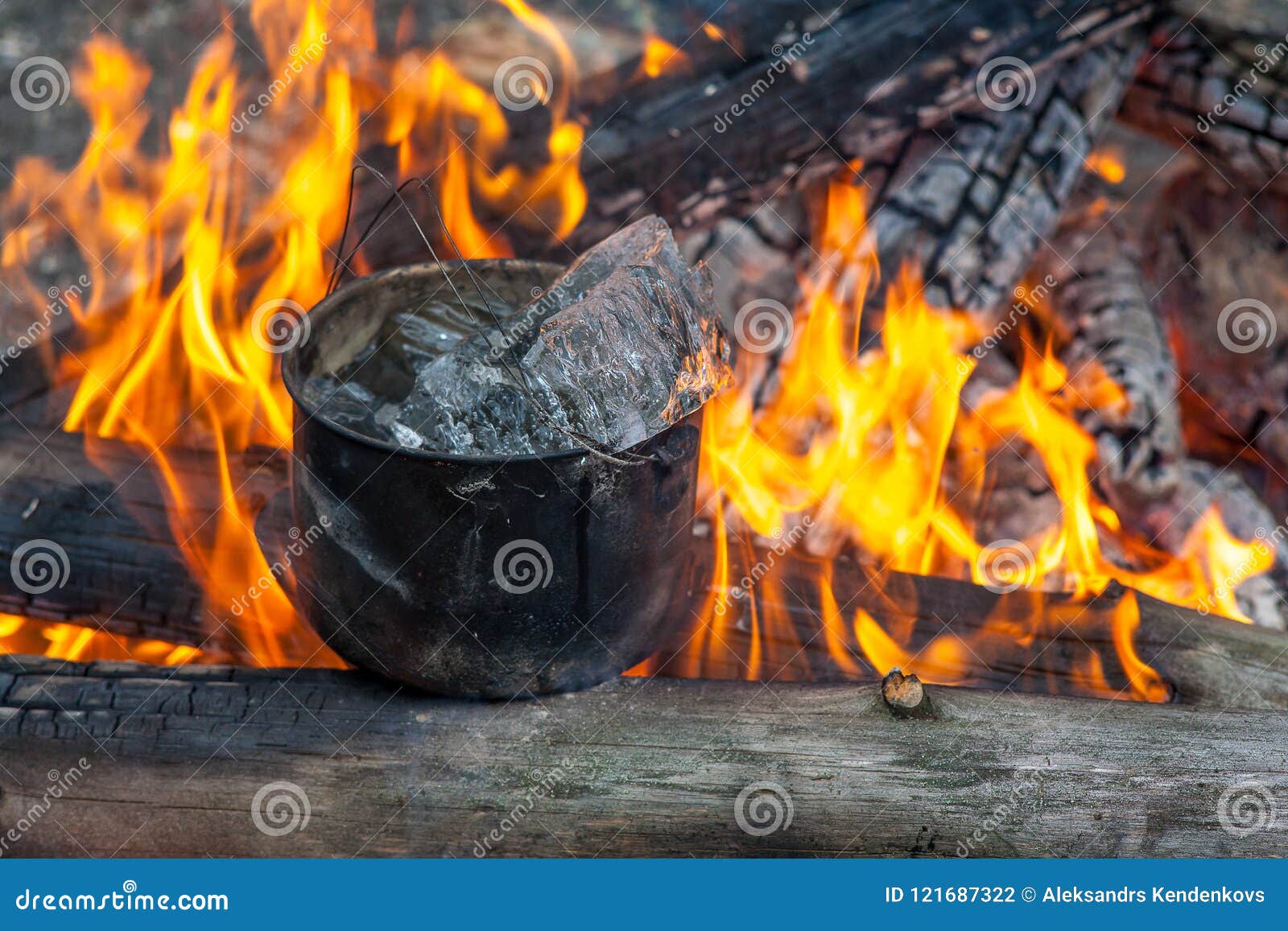 Cooking in the Nature. Cauldron with Ice on Fire in Forest. Kitchen in ...