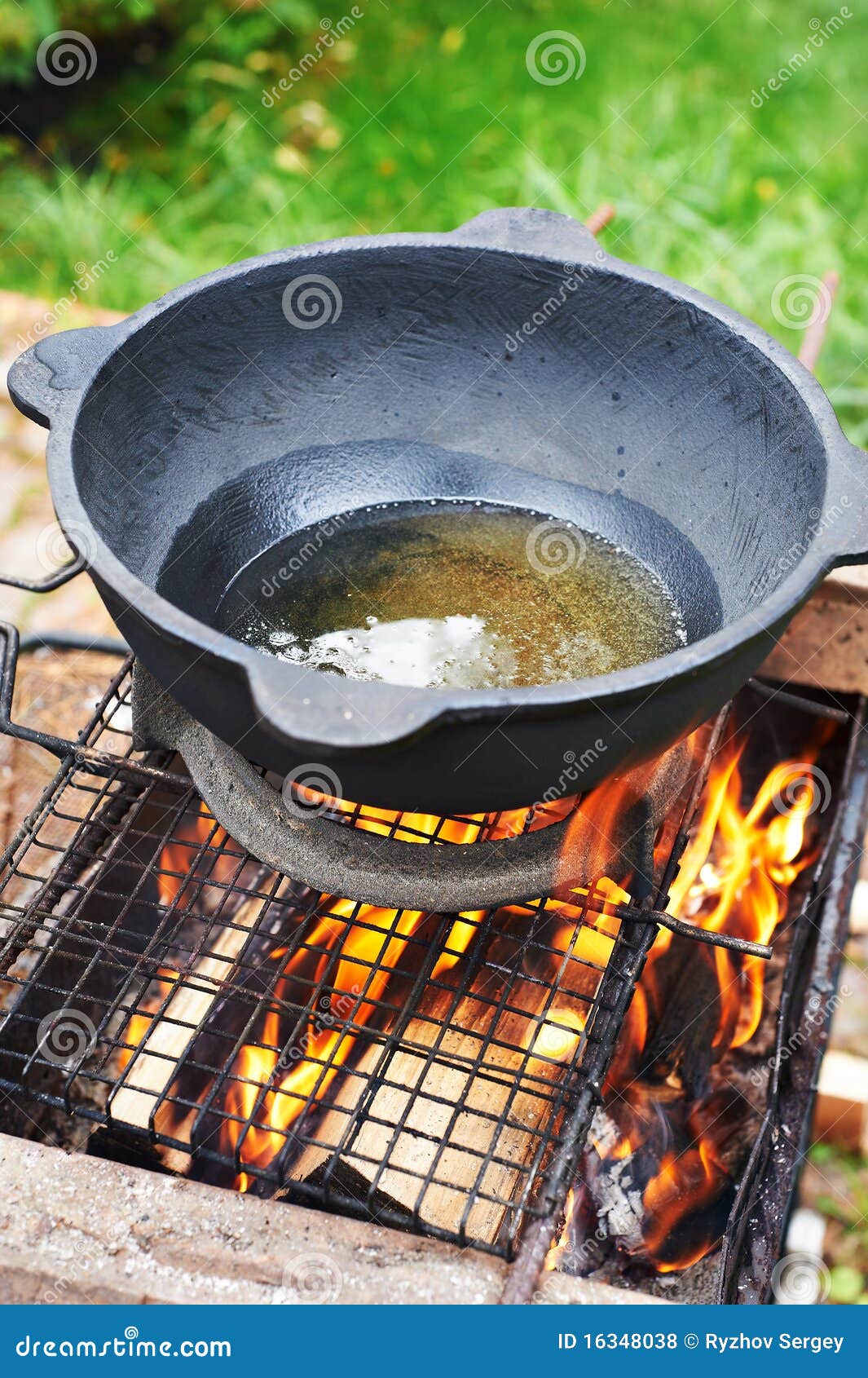 Cauldron of Oil for Pilaf on Lattice of Barbecue. Stock Photo - Image ...