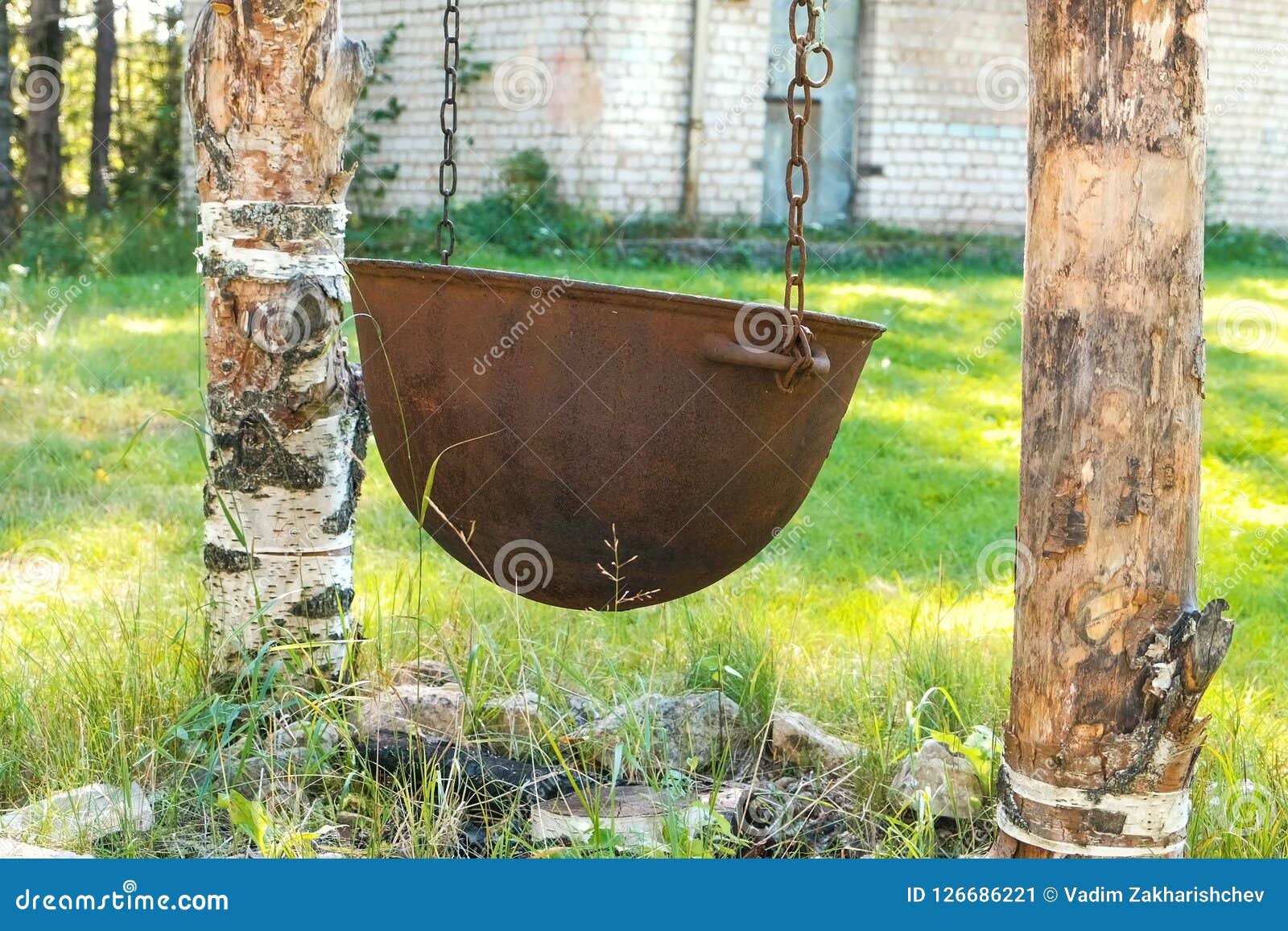 Cauldron, Pot for Cooking Hanging on Chains Over the Fire. Stock Image ...