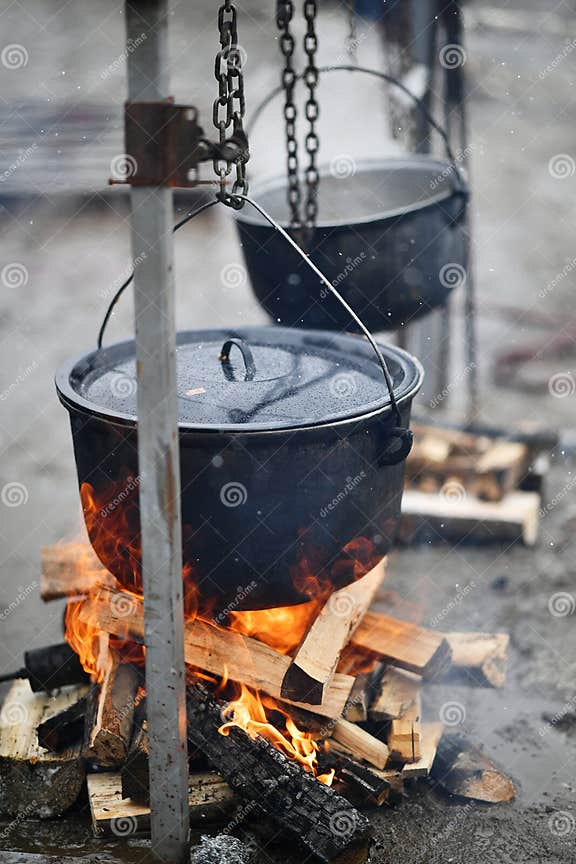 Cauldrons over the fire stock photo. Image of outdoorn - 110829426