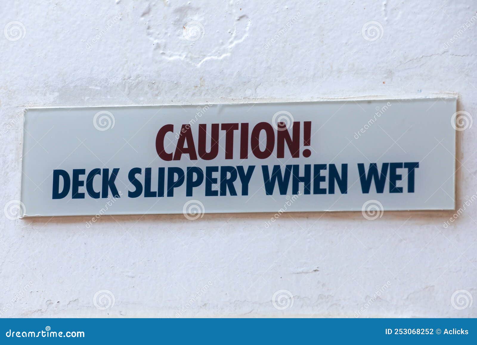 Caution Deck Slippery when Wet Sign on a White Wall Stock Photo - Image ...