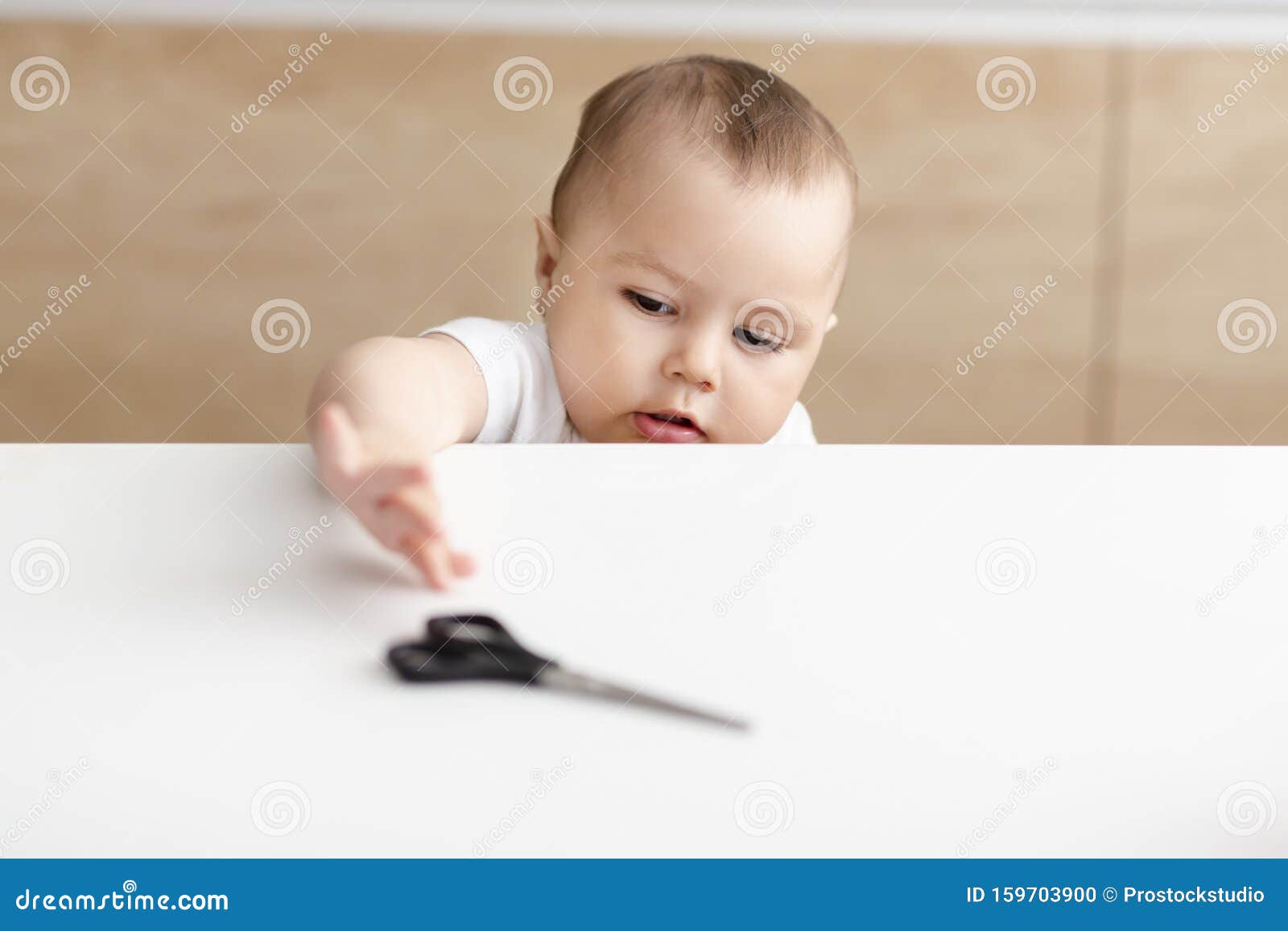 Baby Boy Trying To Get Scissors from Kitchen Table Stock Photo - Image ...