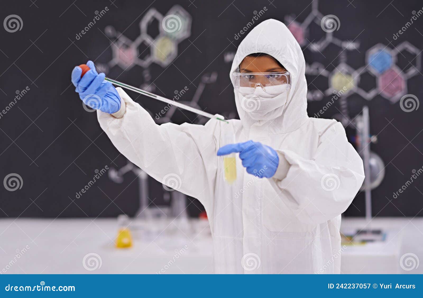 Caution in the Lab. a Young Scientist in Protective Clothing Using a ...