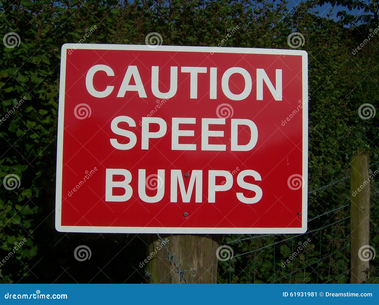 Caution Speed Bumps Sign stock image. Image of bushes - 61931981