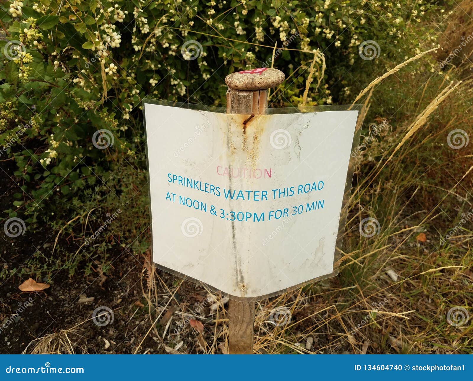Caution Sprinklers Water this Road Sign on Stake Stock Photo - Image of ...