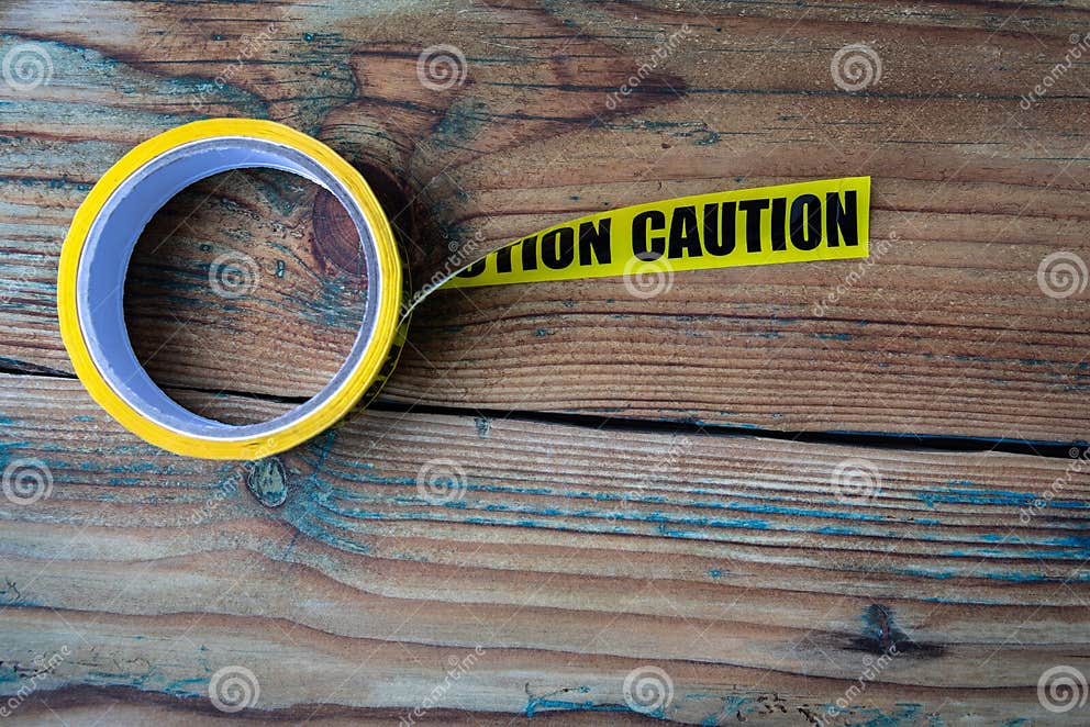 Caution Tape on a Wooden Texture Table Stock Image - Image of ...