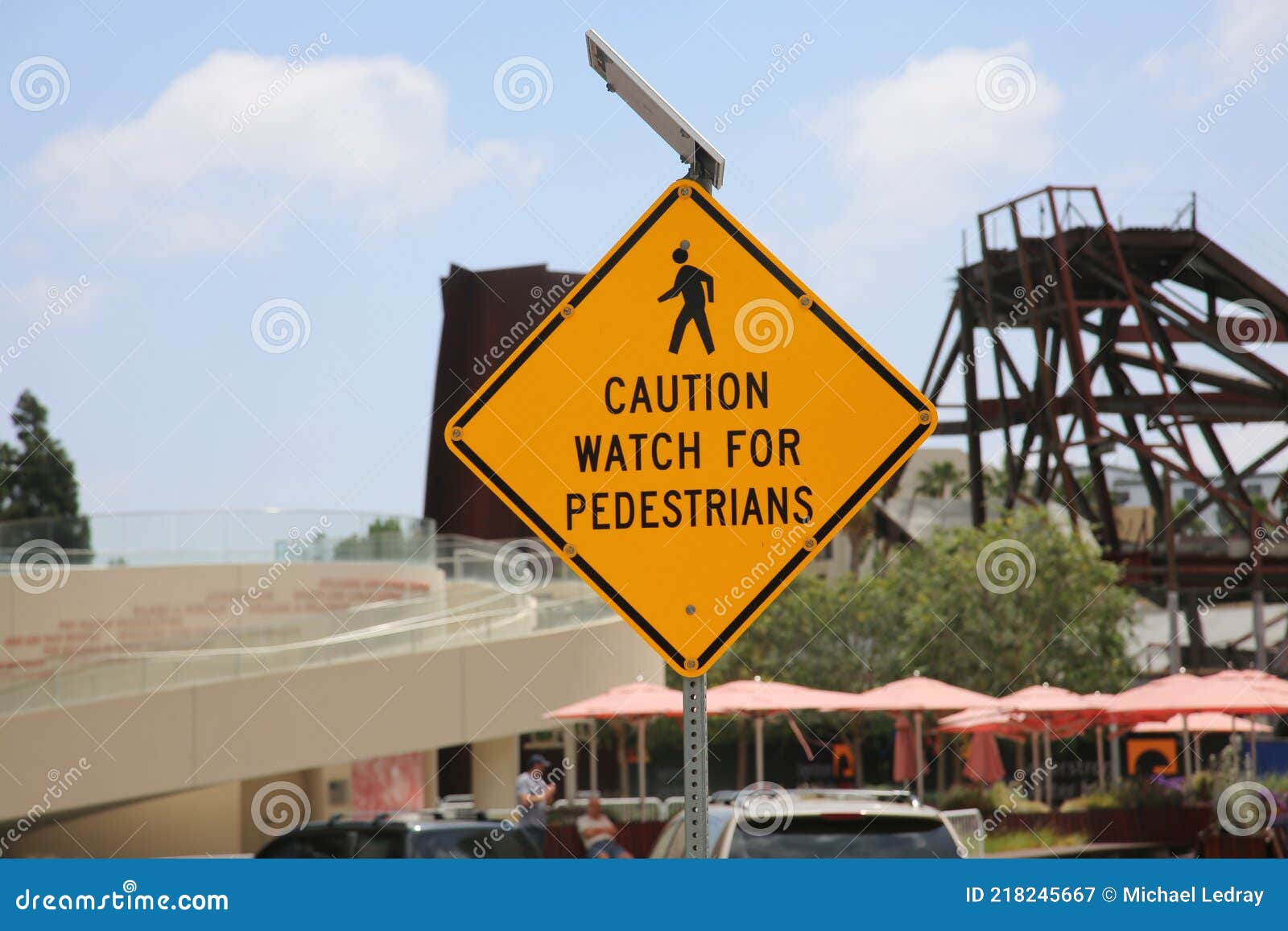 A Caution Watch For Pedestrians On The Road Sign Laying On The Ground ...