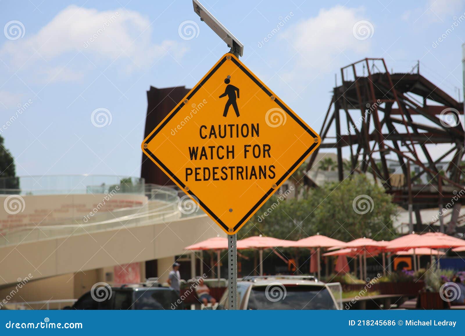 A Caution Watch For Pedestrians On The Road Sign Laying On The Ground ...