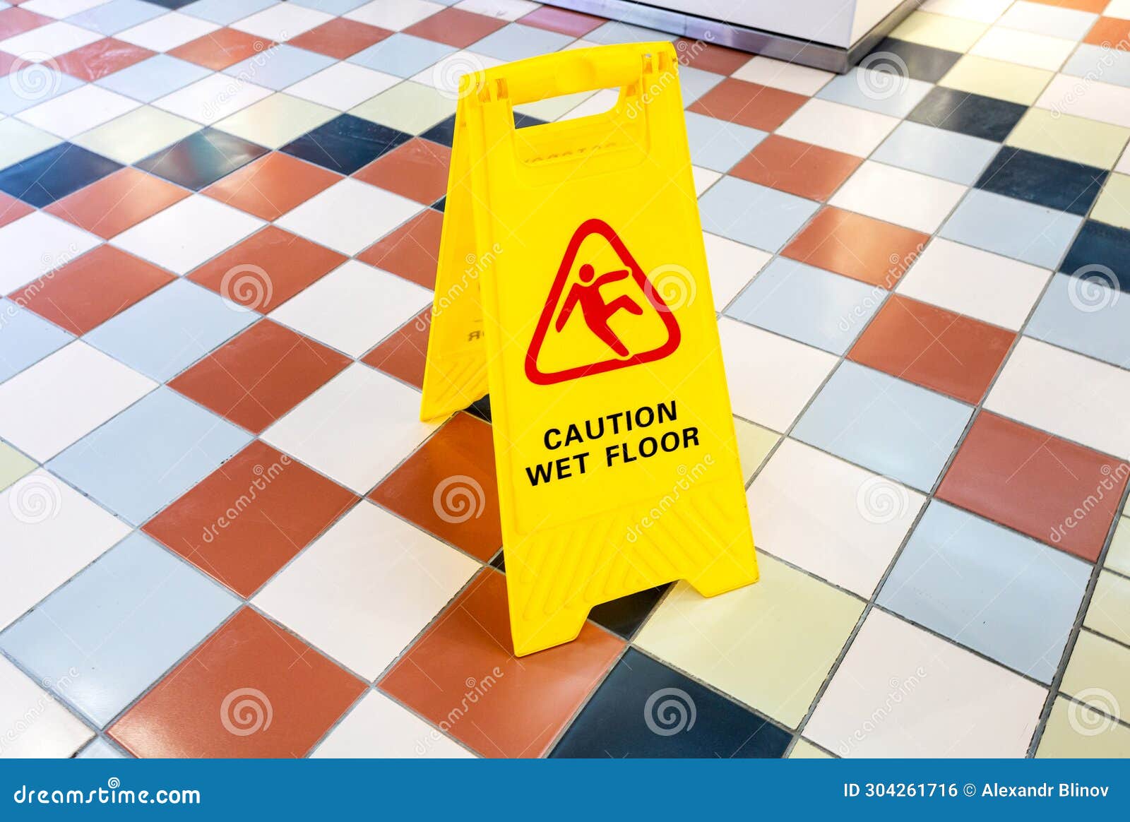 Caution Wet Floor Warning Sign on a Tile Floor in a Superstore Stock ...