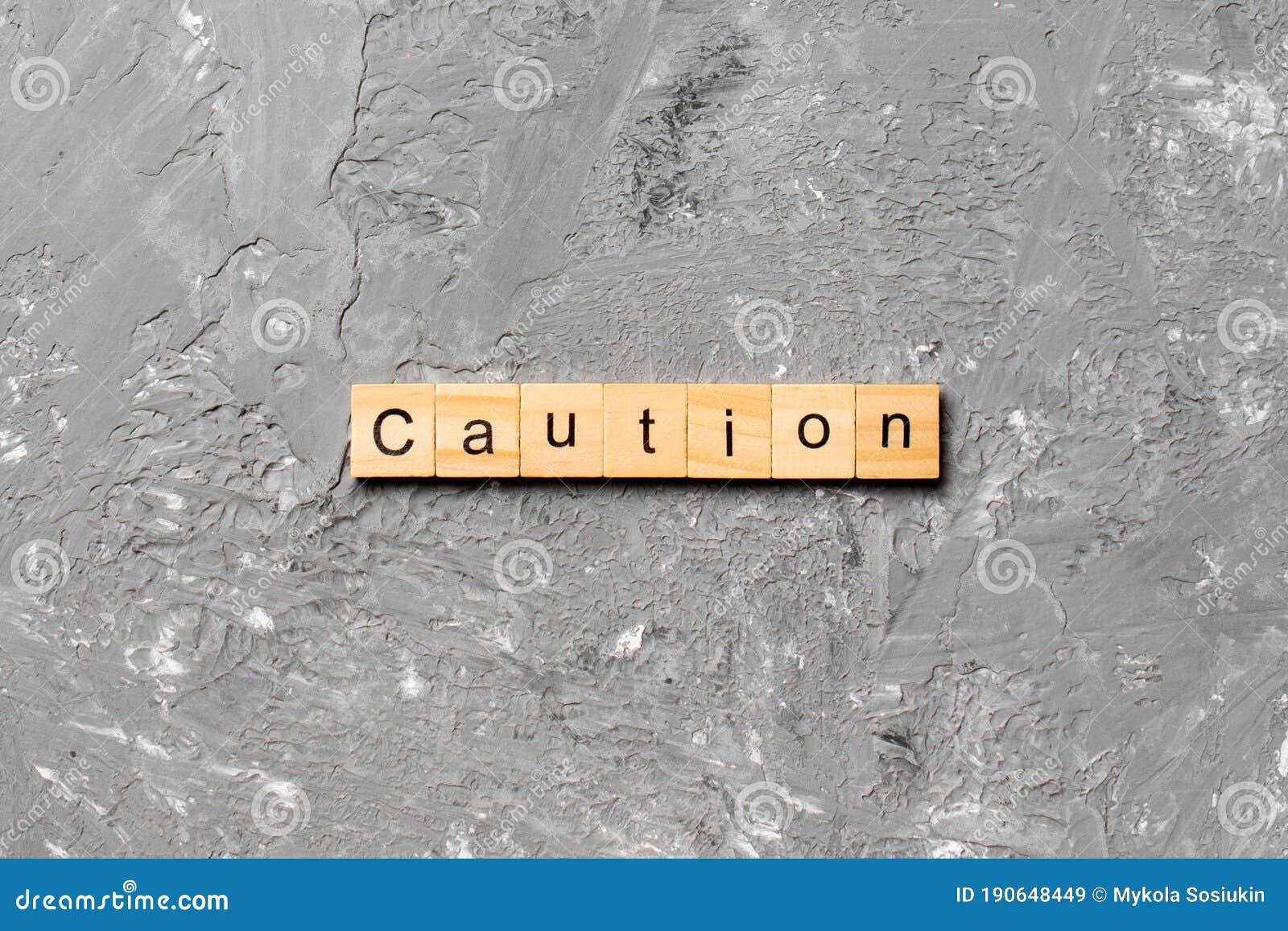 CAUTION Word Written on Wood Block. CAUTION Text on Cement Table for ...