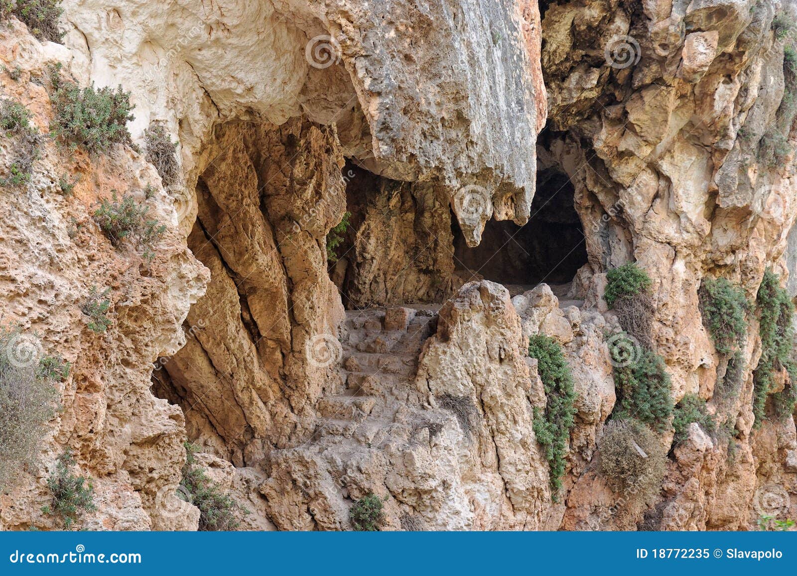 Cave Entrance In Huge Cliff In The Forest With Man Standing In Front ...