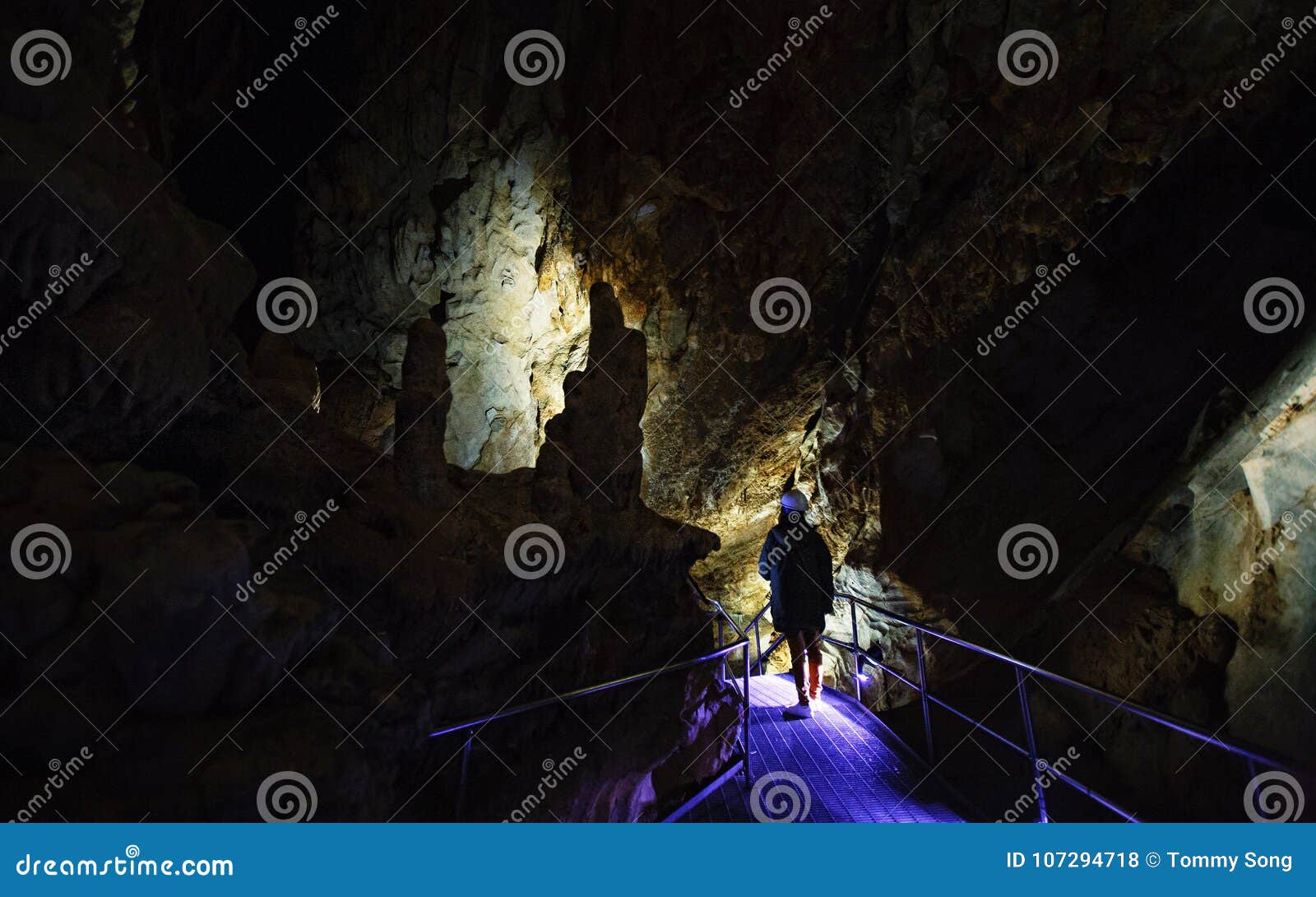 The Cave Explorer Looks At The Icy Stalagmite Royalty-Free Stock ...