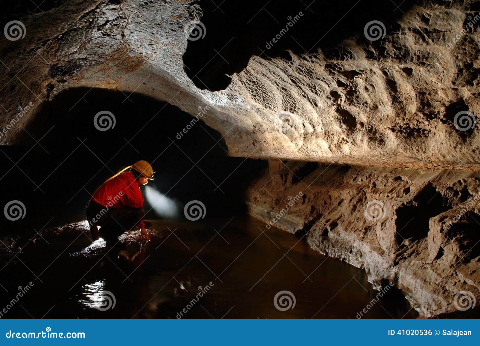 The Cave Explorer Looks At The Icy Stalagmite Royalty-Free Stock ...