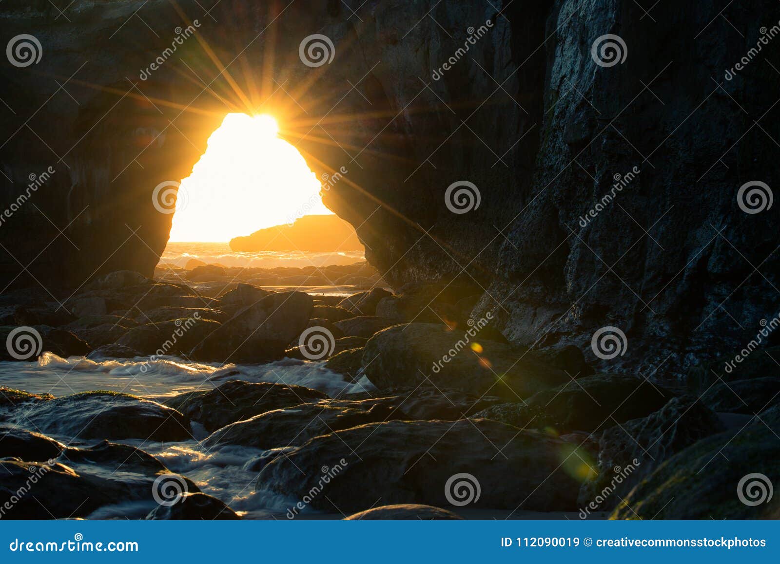 Cave Near Body Of Water At Sunset Picture. Image: 112090019