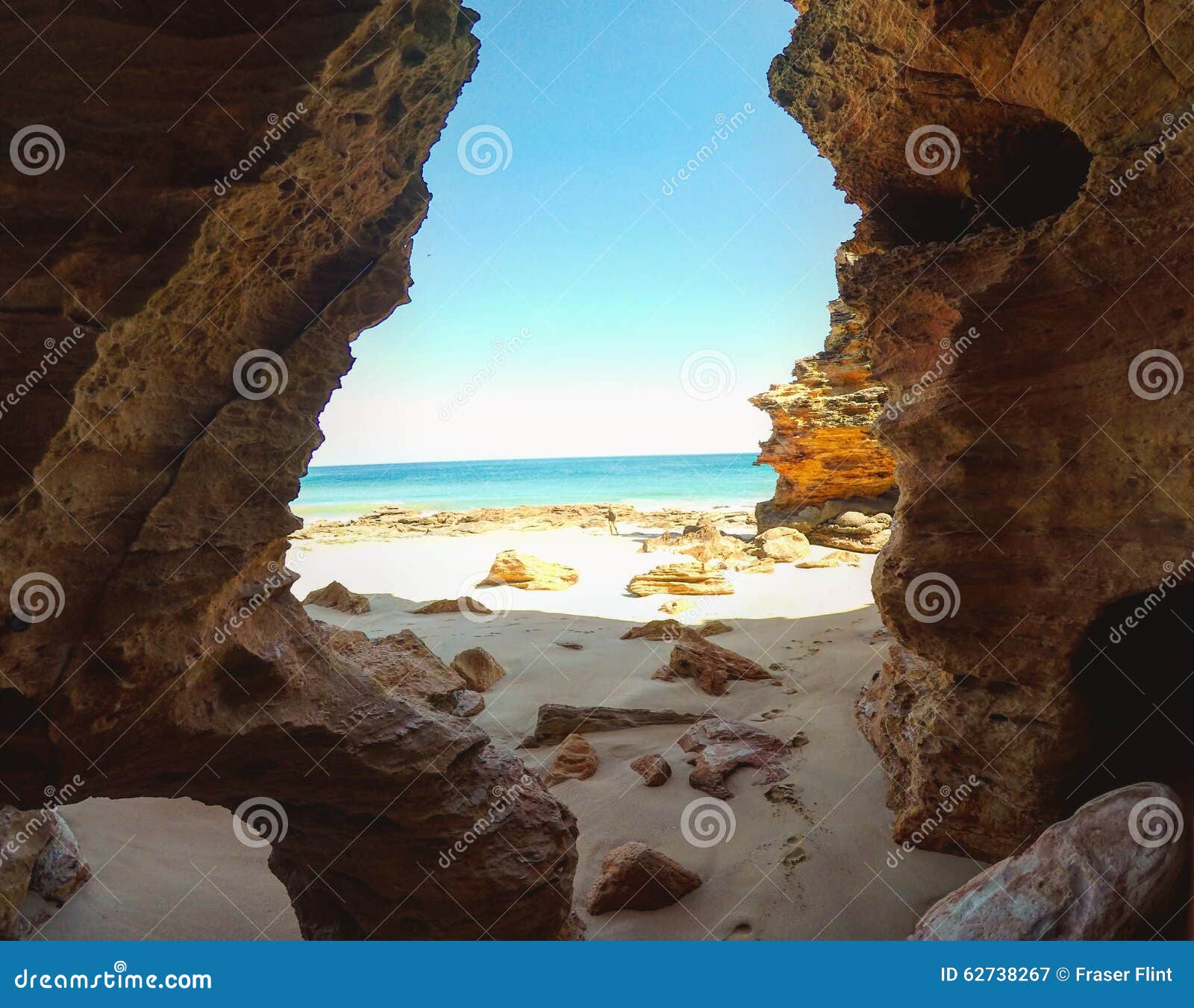 Cave opening onto a beach stock image. Image of distance - 62738267