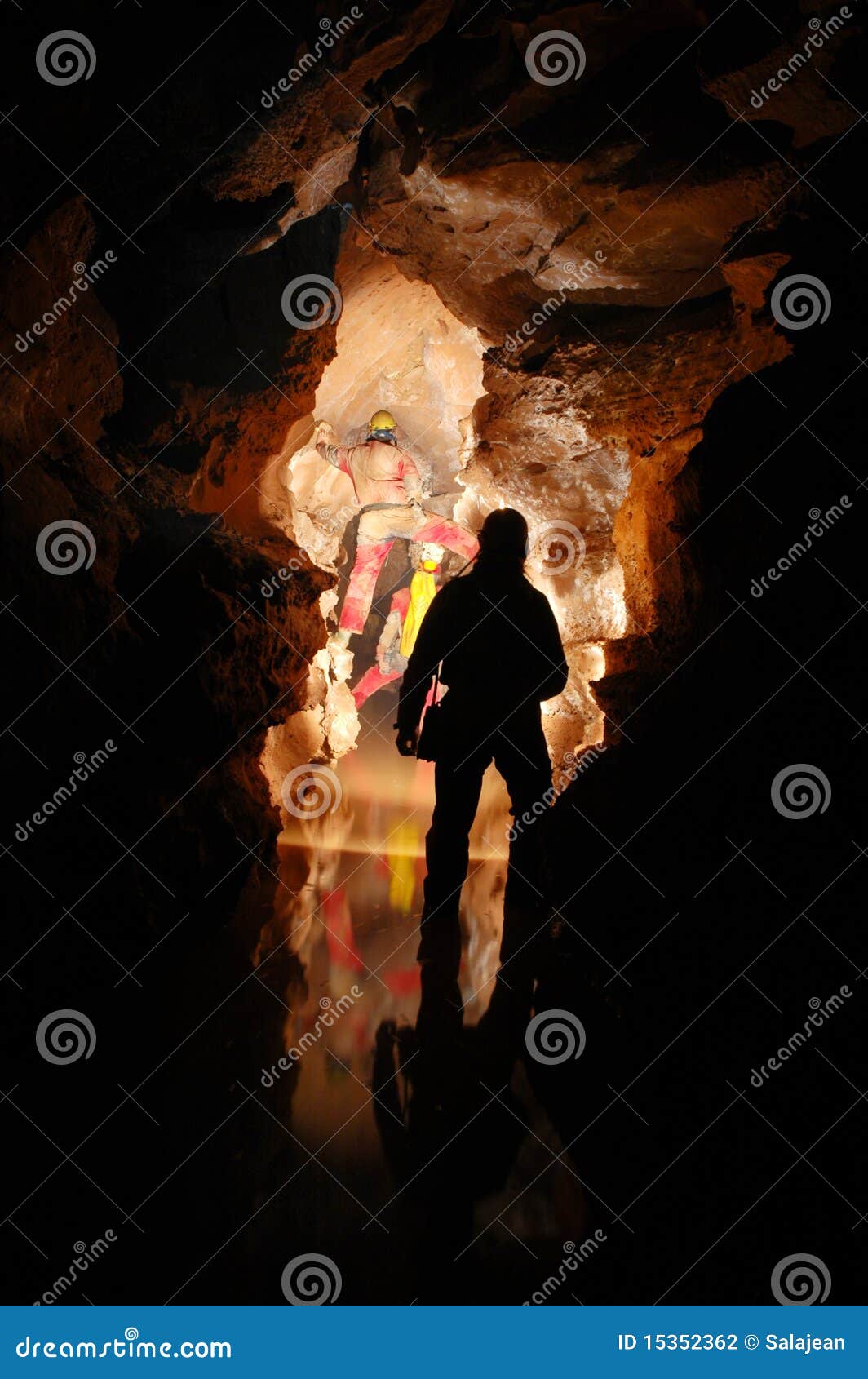 Cave passage with cavers stock photo. Image of geology - 15352362