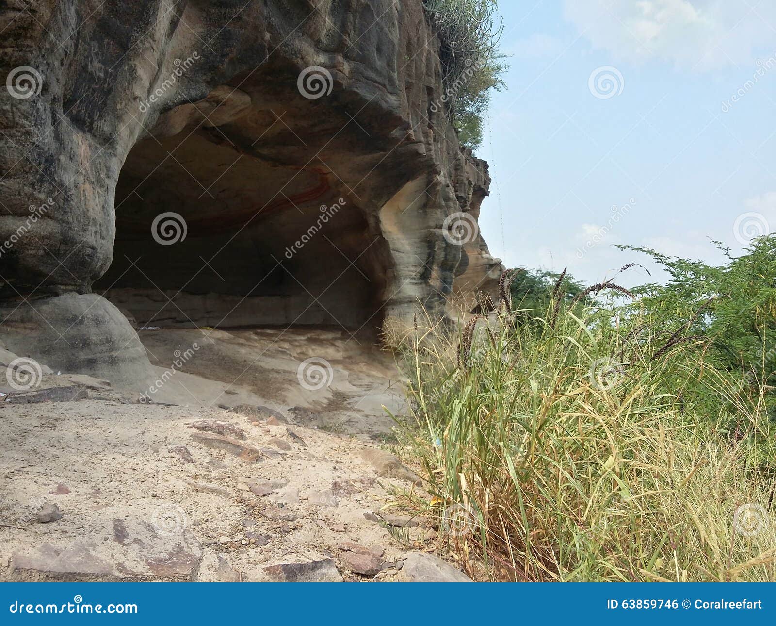 Cave in Scrubland with Field Grass Outside Stock Photo - Image of ...