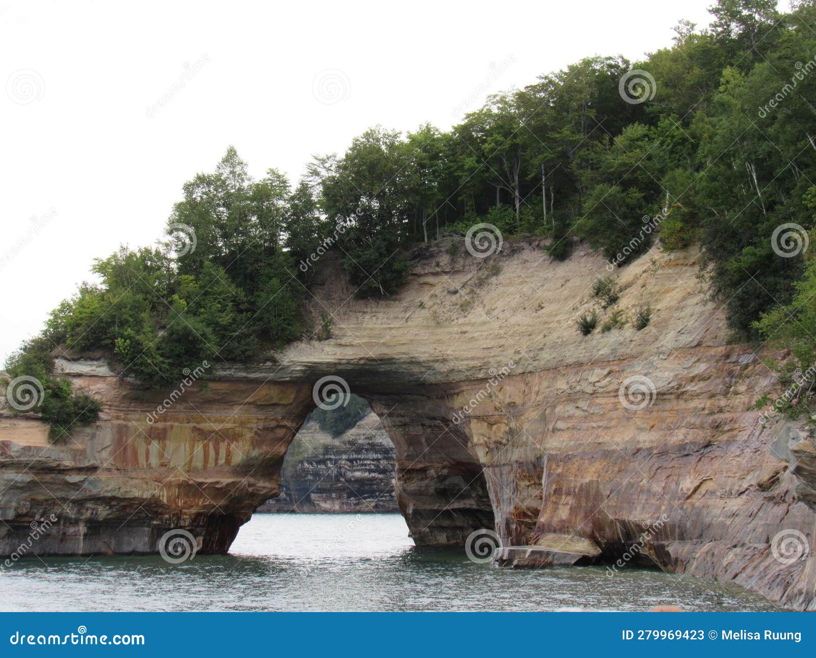 Cave Under a Large Cliff Filled with Trees Stock Image - Image of ...