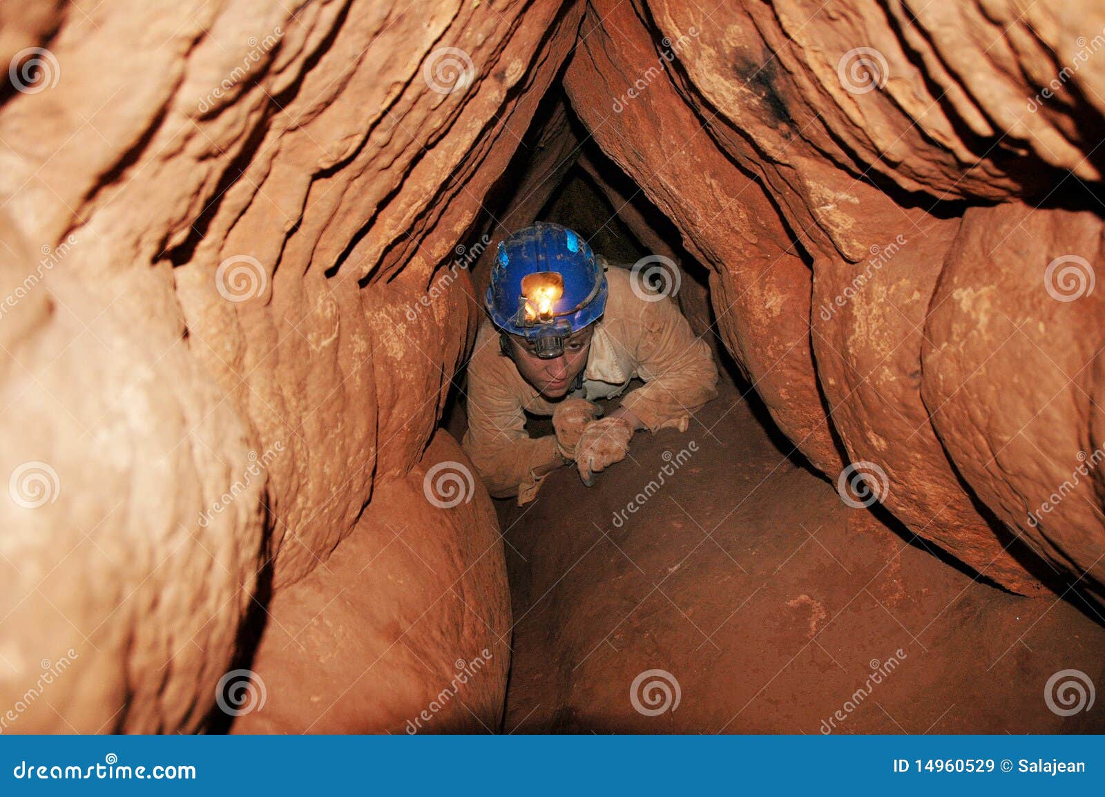 Caver in a narrow passage stock image. Image of climb - 14960529