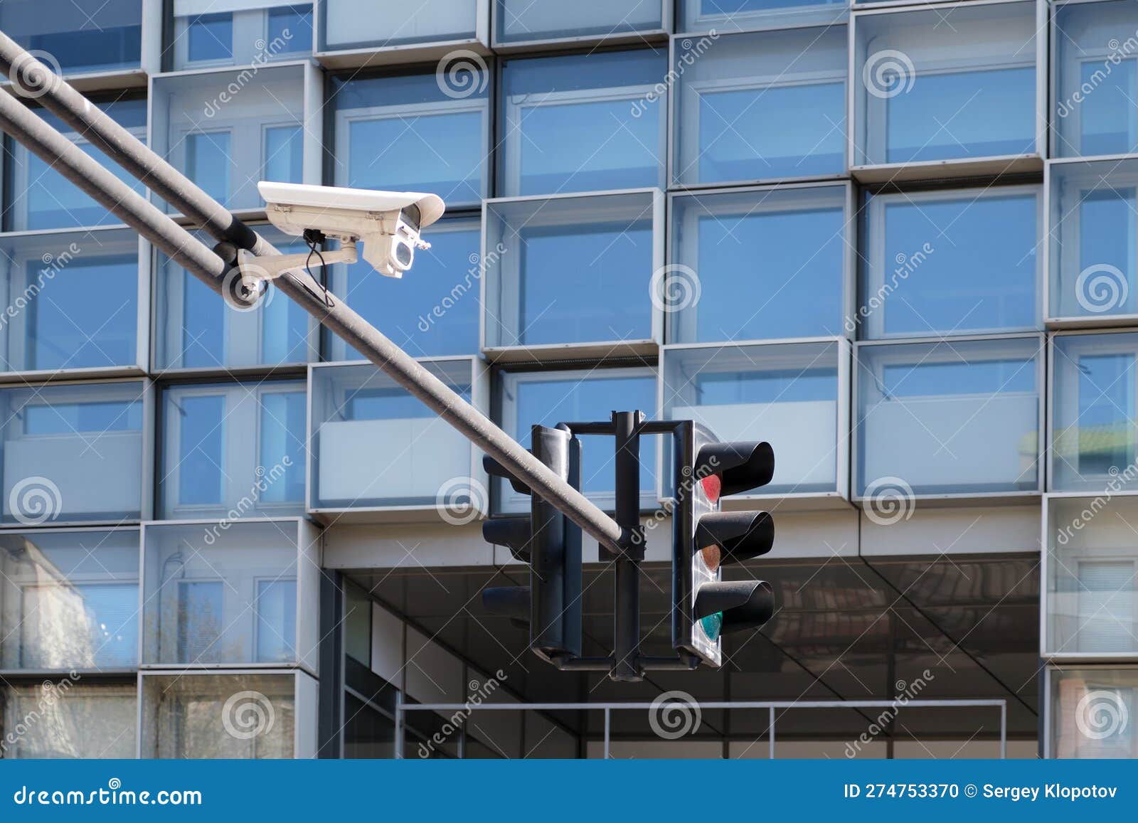 A CCTV Camera is Installed on a Road Pole Along with a Traffic Light ...