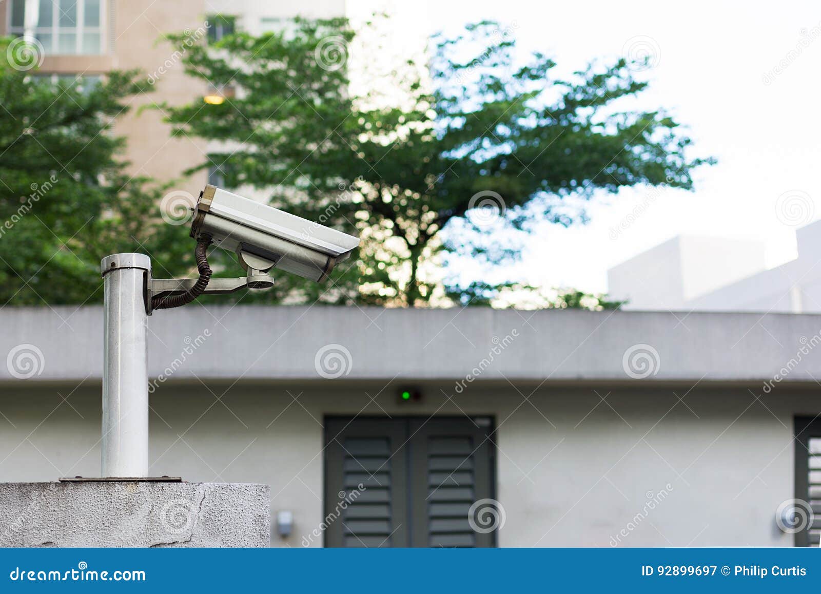 CCTV Camera Mounted on Top of a Wall Watching Over an Area. Stock Image ...