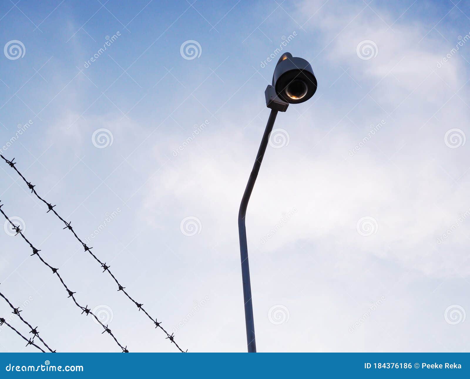 CCTV Security Camera Surveillance System on High Post of Fence Outside ...