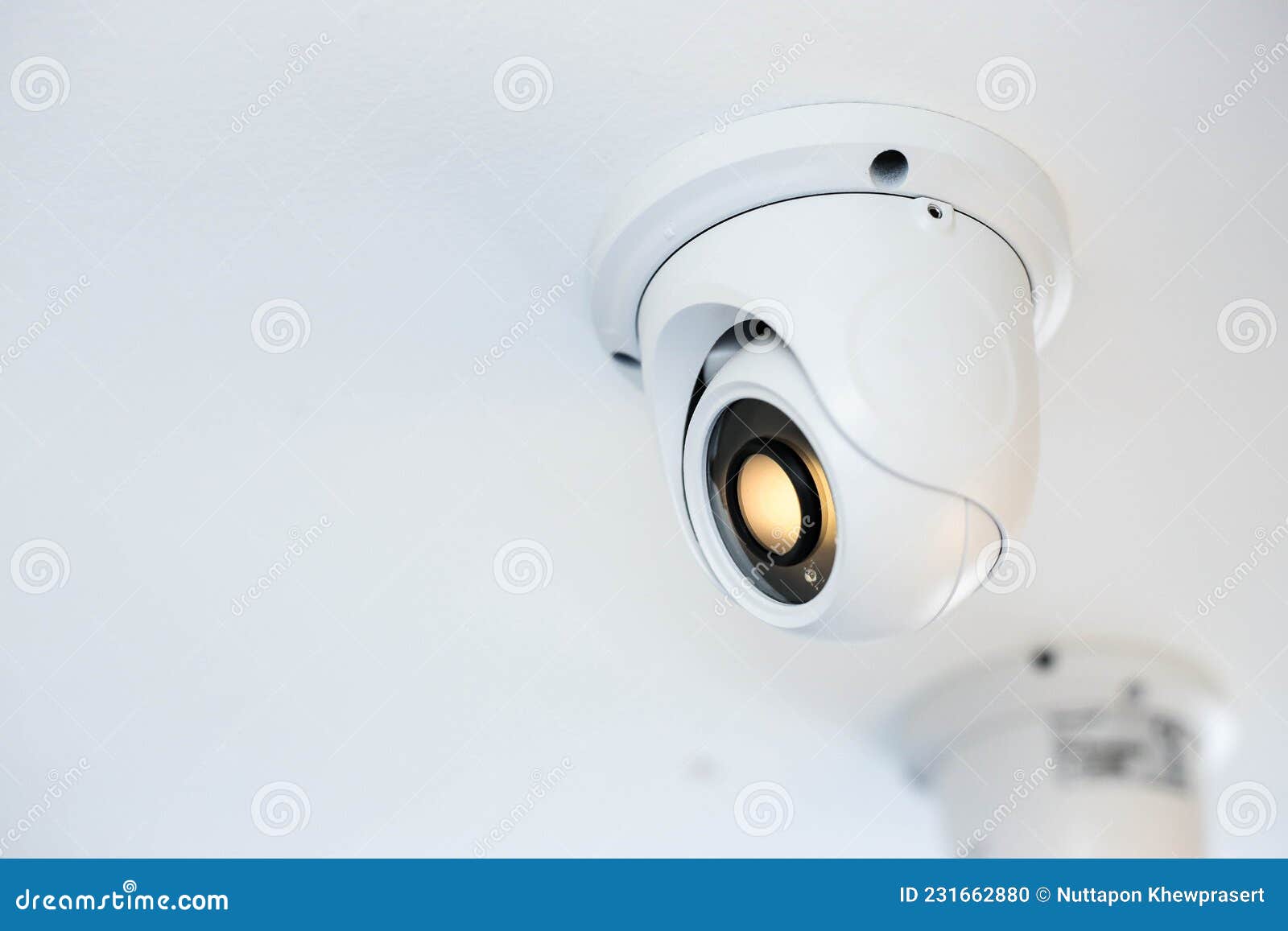 CCTV Security Camera on White Ceiling Operating Inside the Building ...