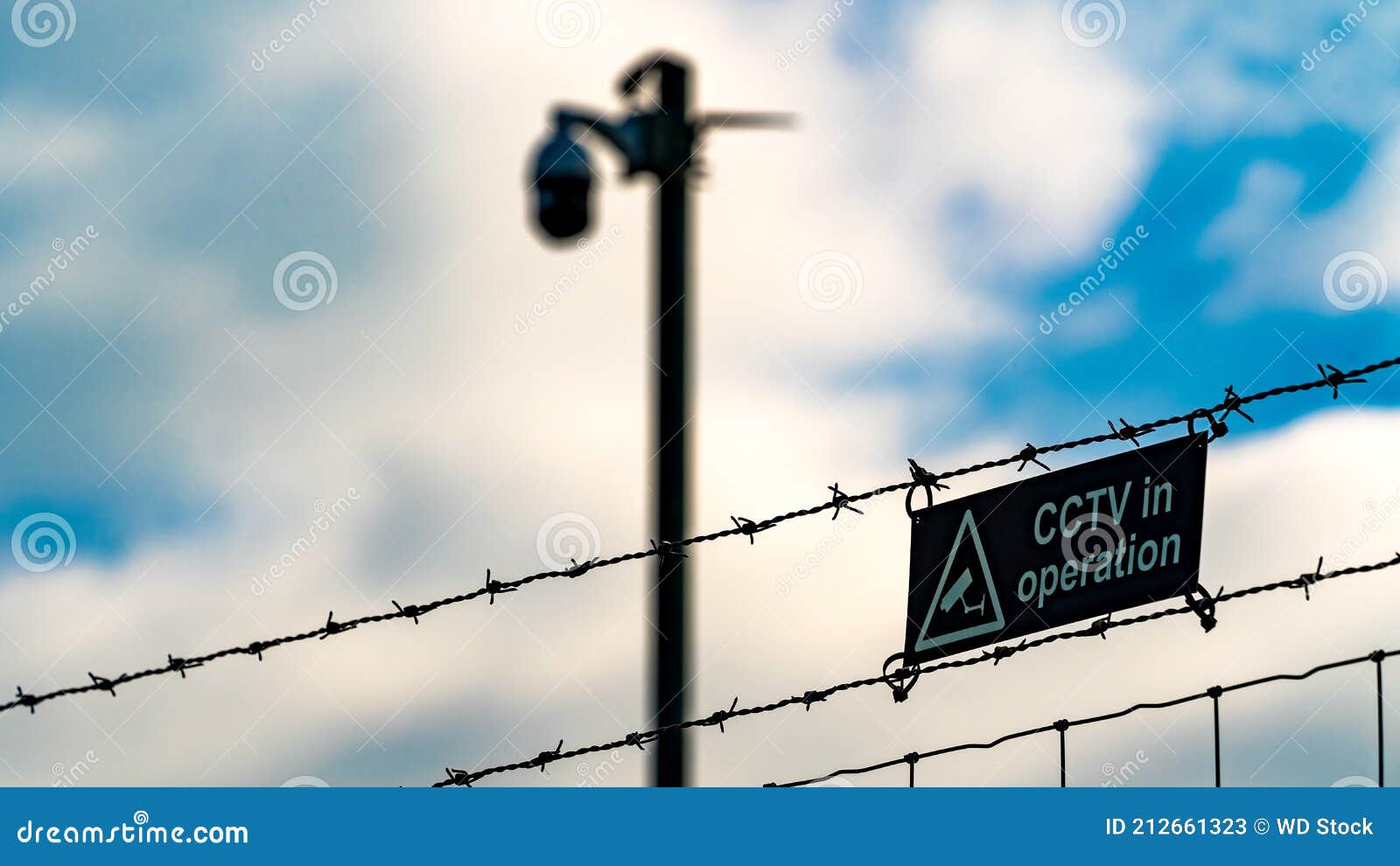 CCTV Warning Sign With Camera In The Background Behind Barbed Wire ...