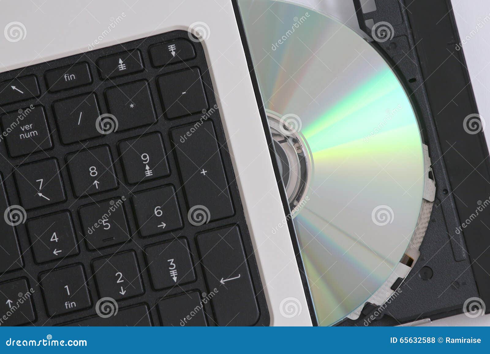 CD into a computer stock photo. Image of laptop, program - 65632588