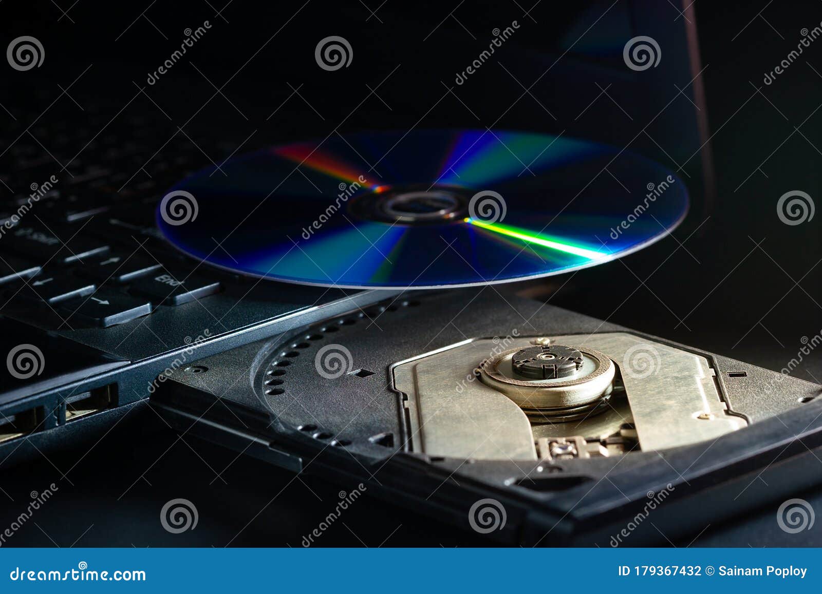 CD on the Computer Notebook Cd Rom in Darkness. Stock Photo - Image of ...
